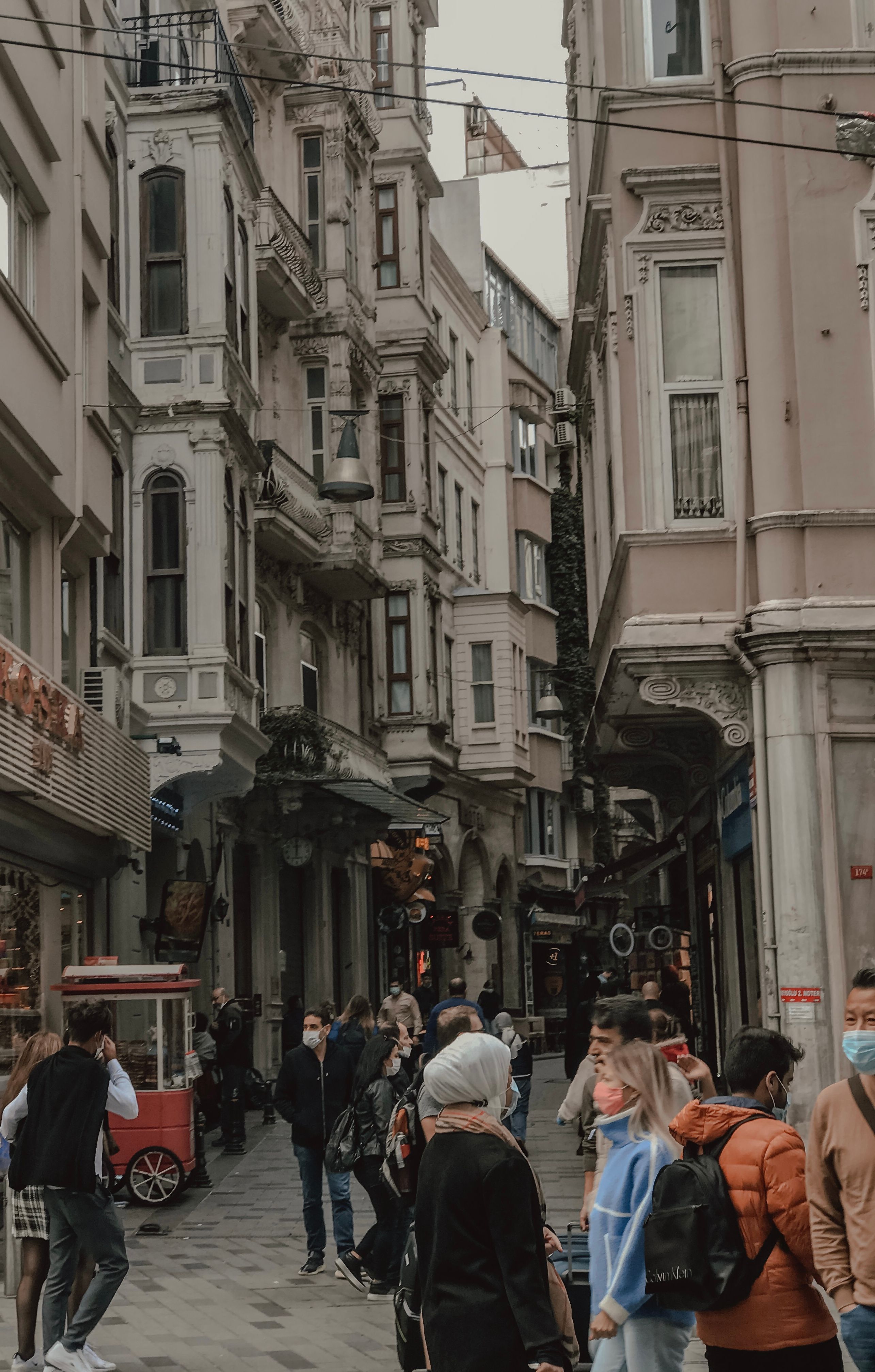 People Walking on the Street Near the Concrete Buildings · Free Stock Photo