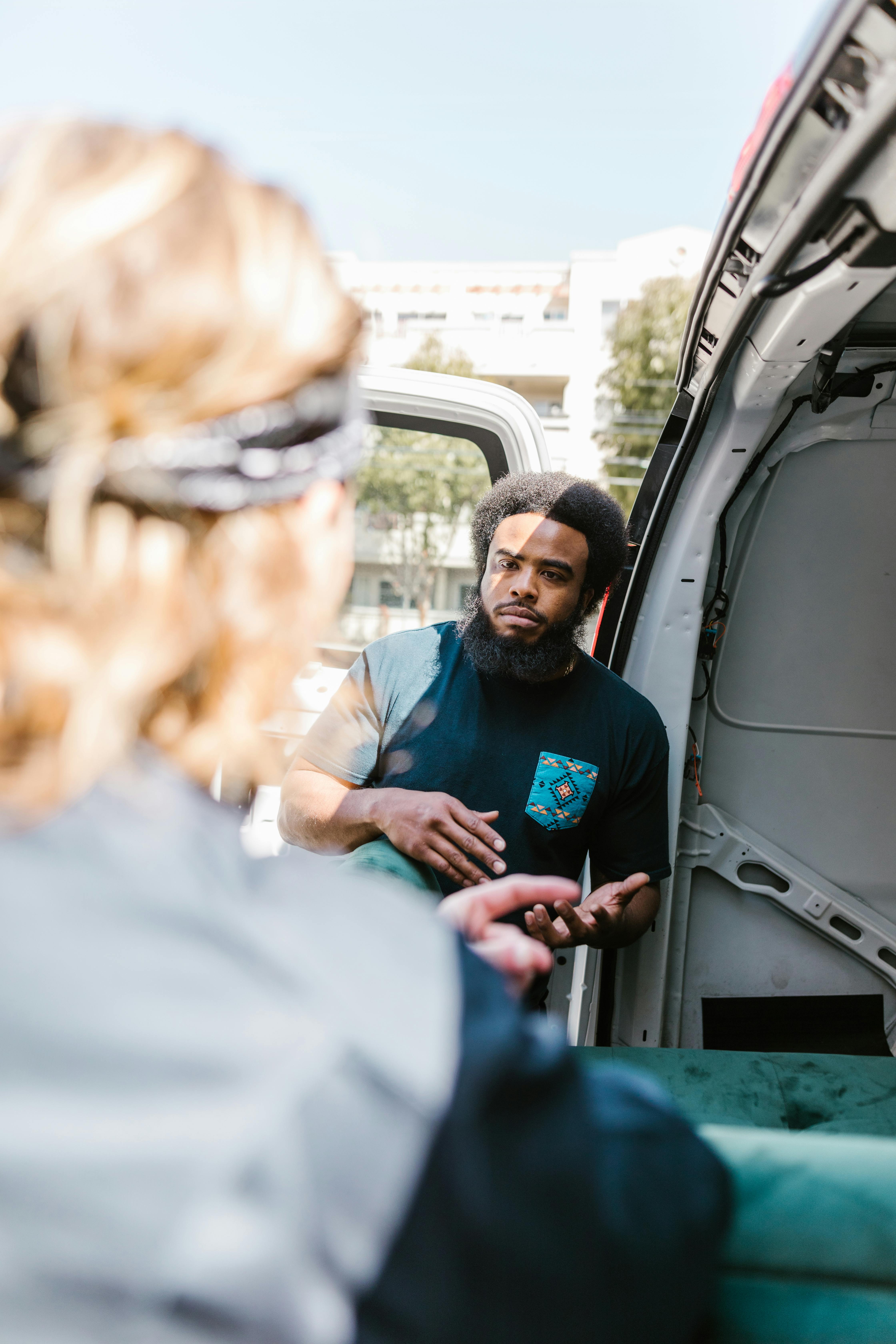Man Wearing Sheet Sitting on a Car · Free Stock Photo