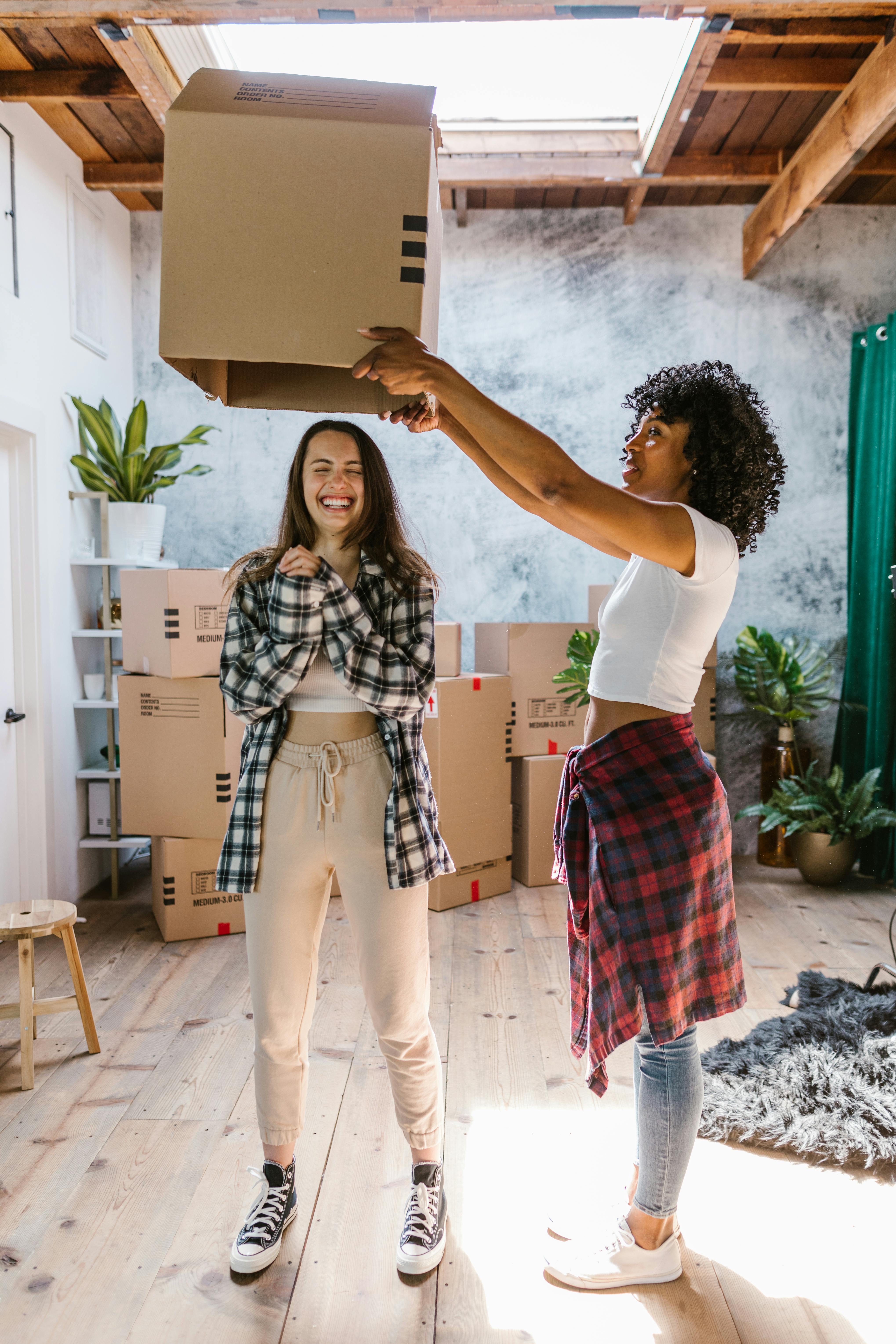 A Woman in White Crop Top Holding Cardboard Box · Free Stock Photo
