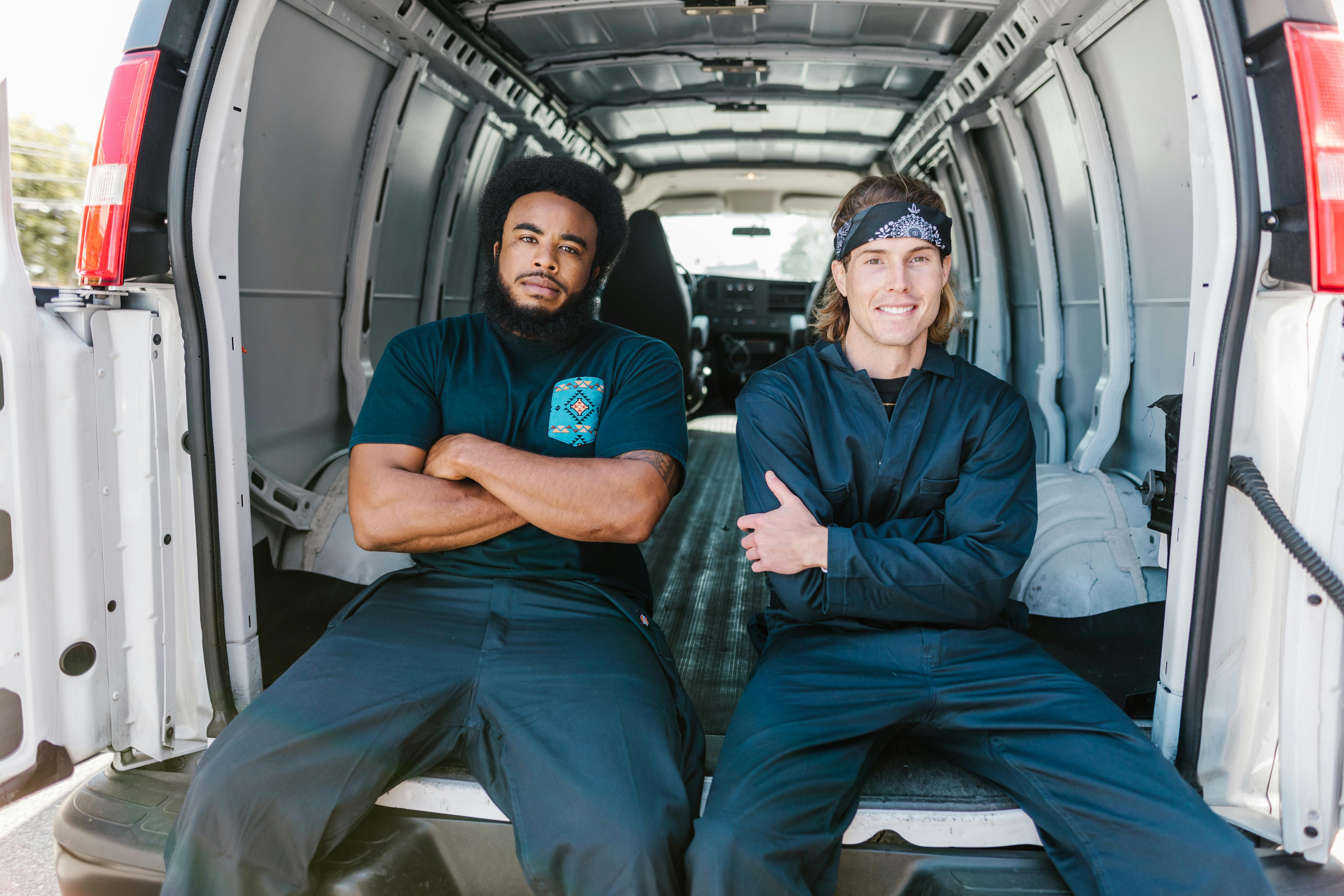 Men in Black Outfit Sitting in a Van · Free Stock Photo