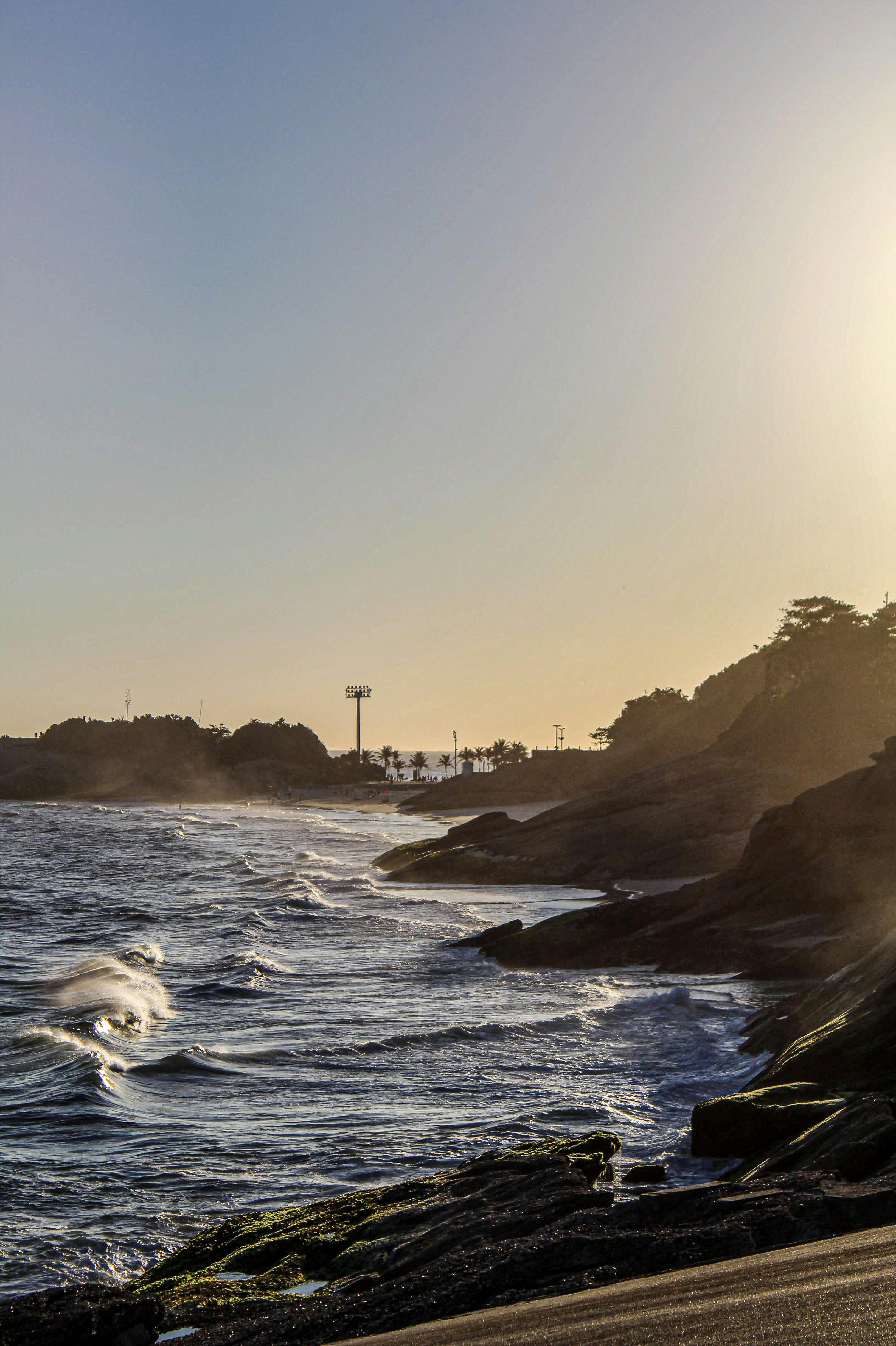 Tidal Waves Beside Mountain Slop during Daytime · Free Stock Photo