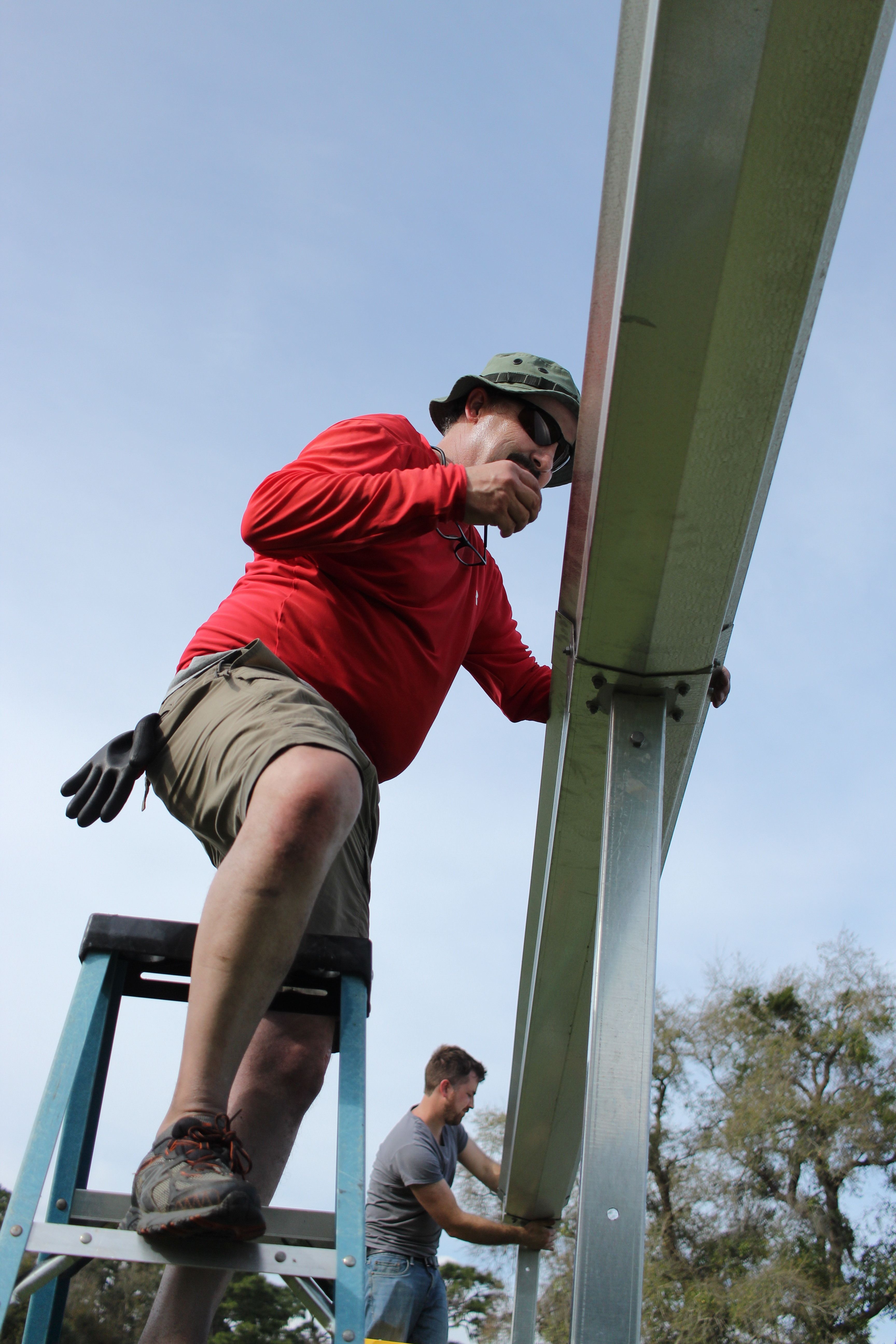 Construction Worker Standing on a Tower · Free Stock Photo
