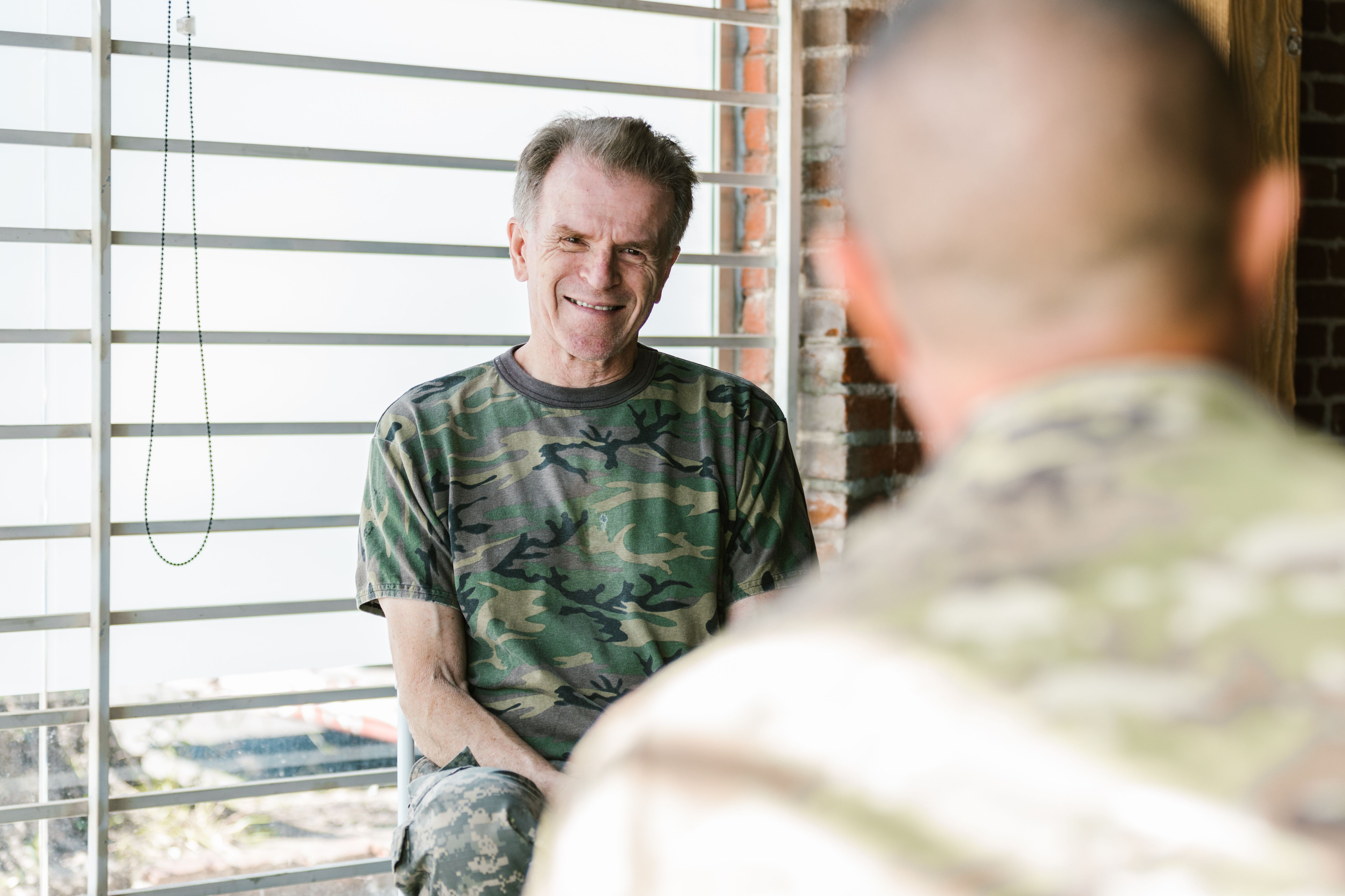 Photo of Veteran Sitting Beside Wndow · Free Stock Photo