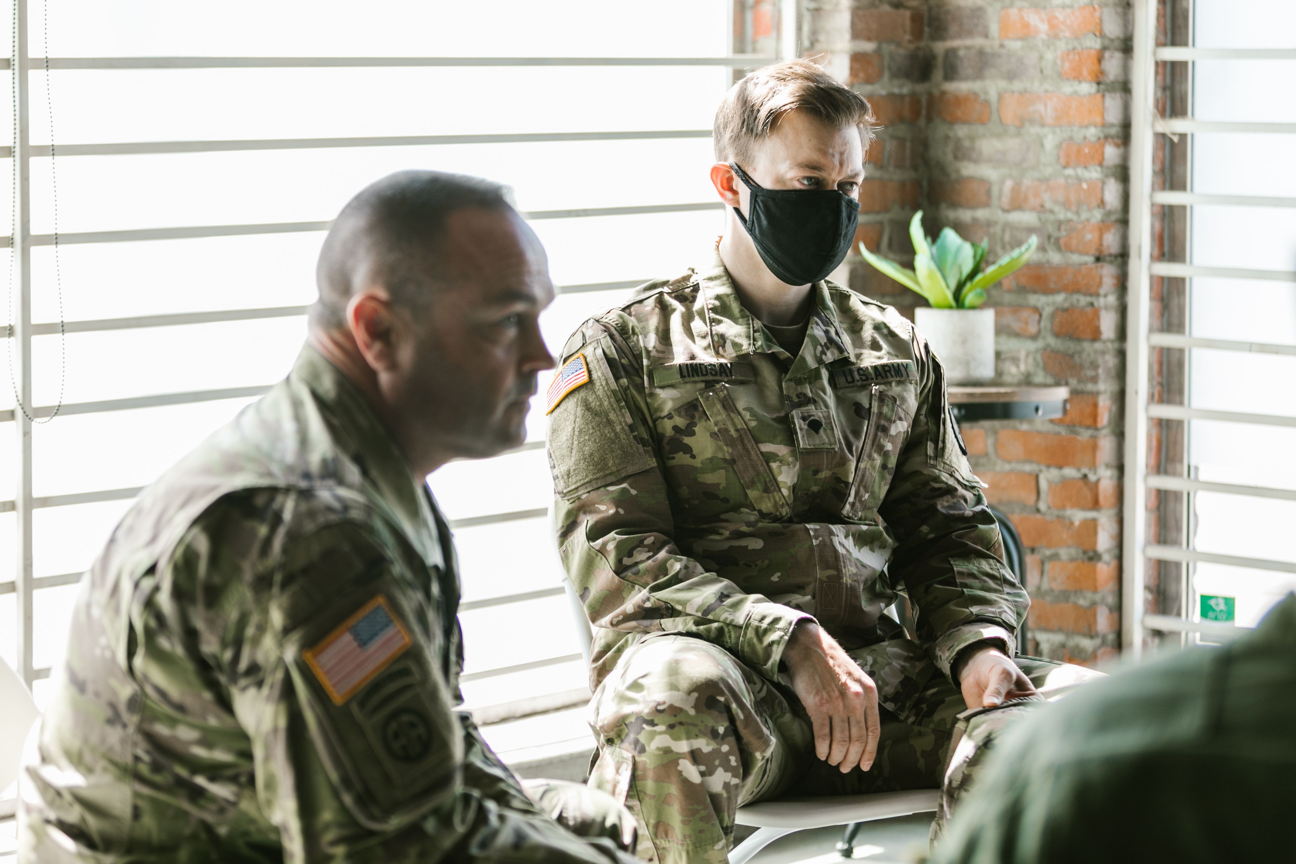 Photo of Soldiers Sitting Beside Each Other · Free Stock Photo