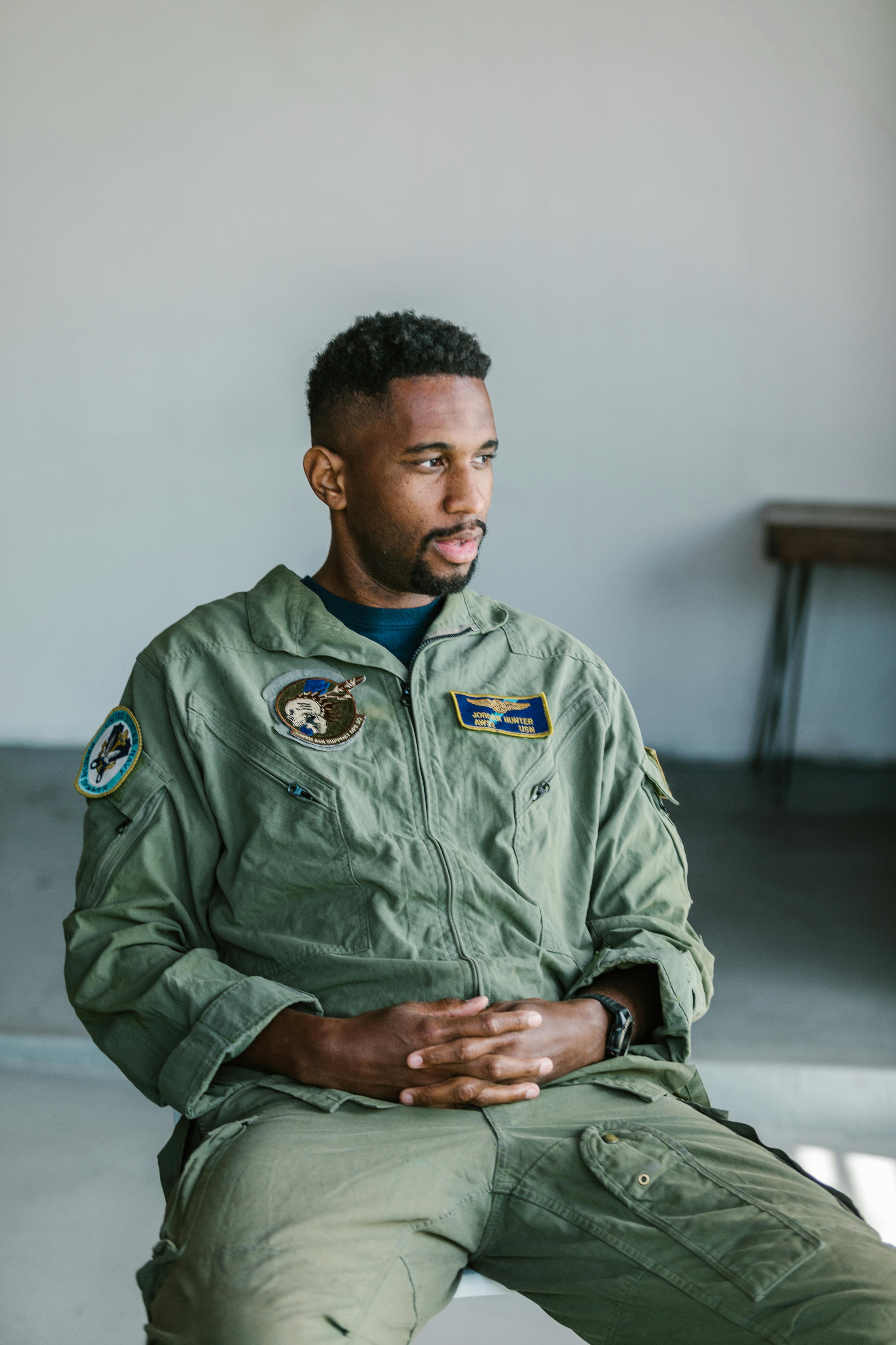 Man Wearing Military Uniform Carrying a Backpack · Free Stock Photo