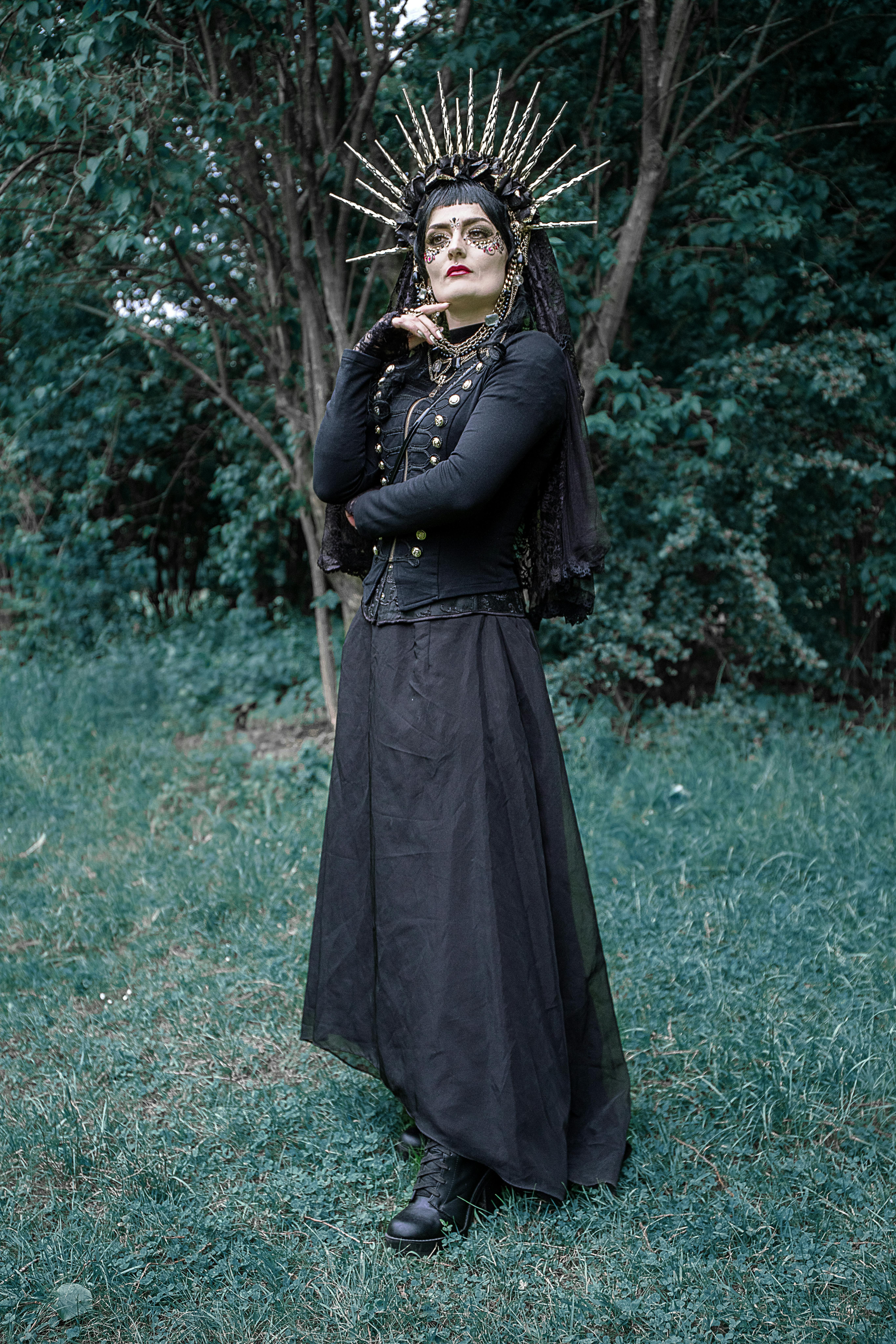 Woman in Black Dress Wearing a Spiky Headdress · Free Stock Photo