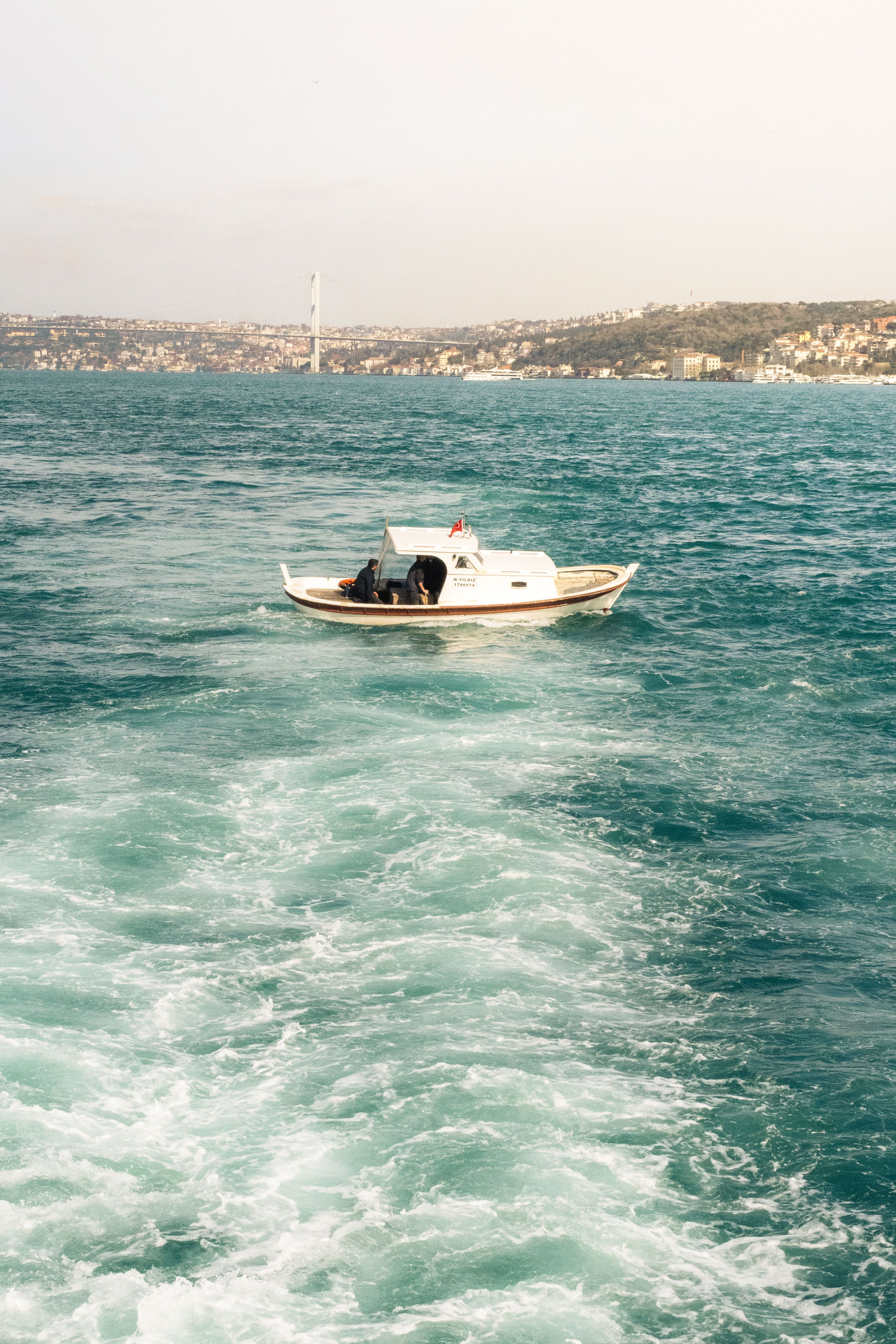 Photo of a White Boat on a Blue Sea · Free Stock Photo