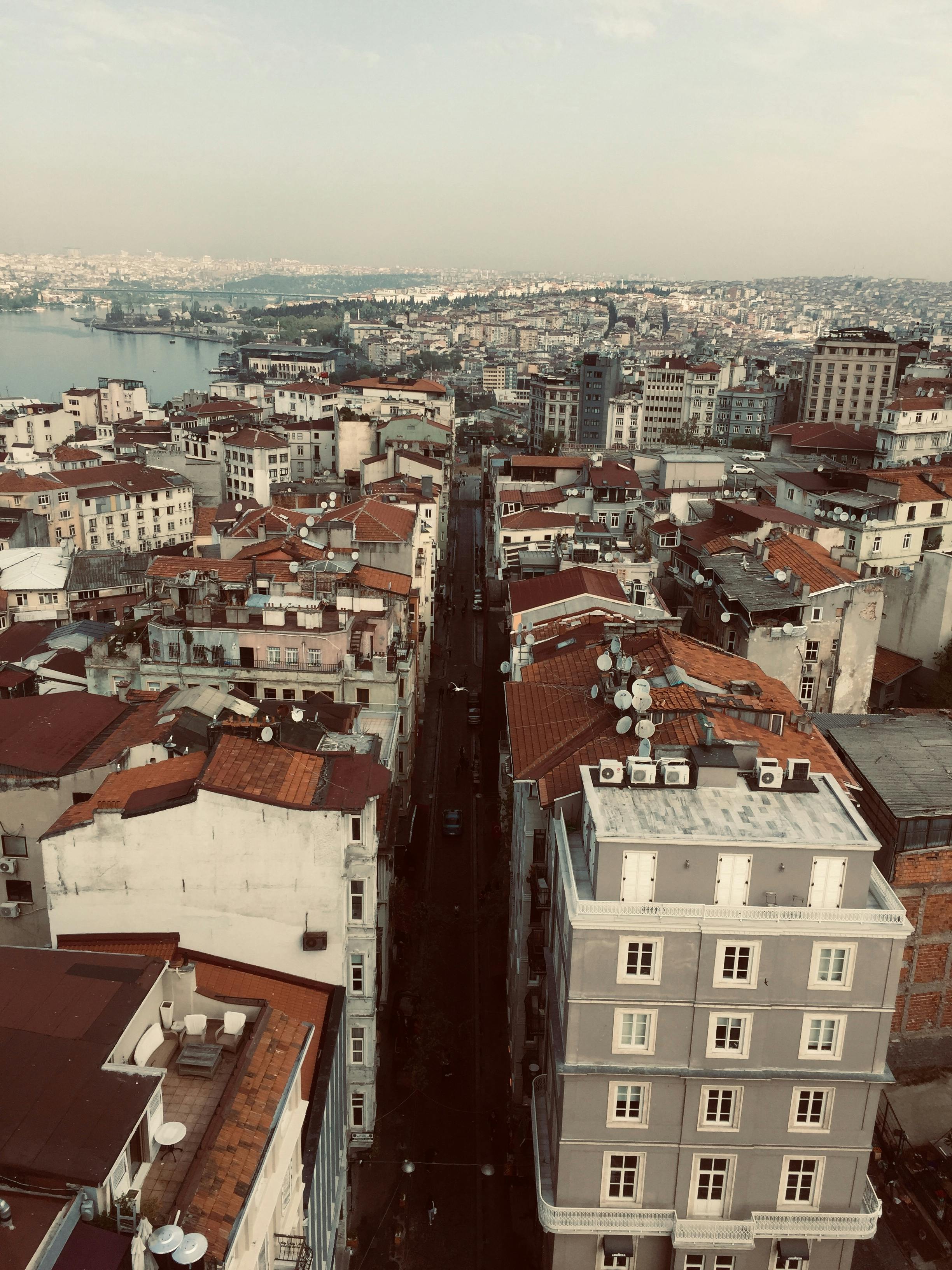 City Buildings Roofs against Blue Sky · Free Stock Photo