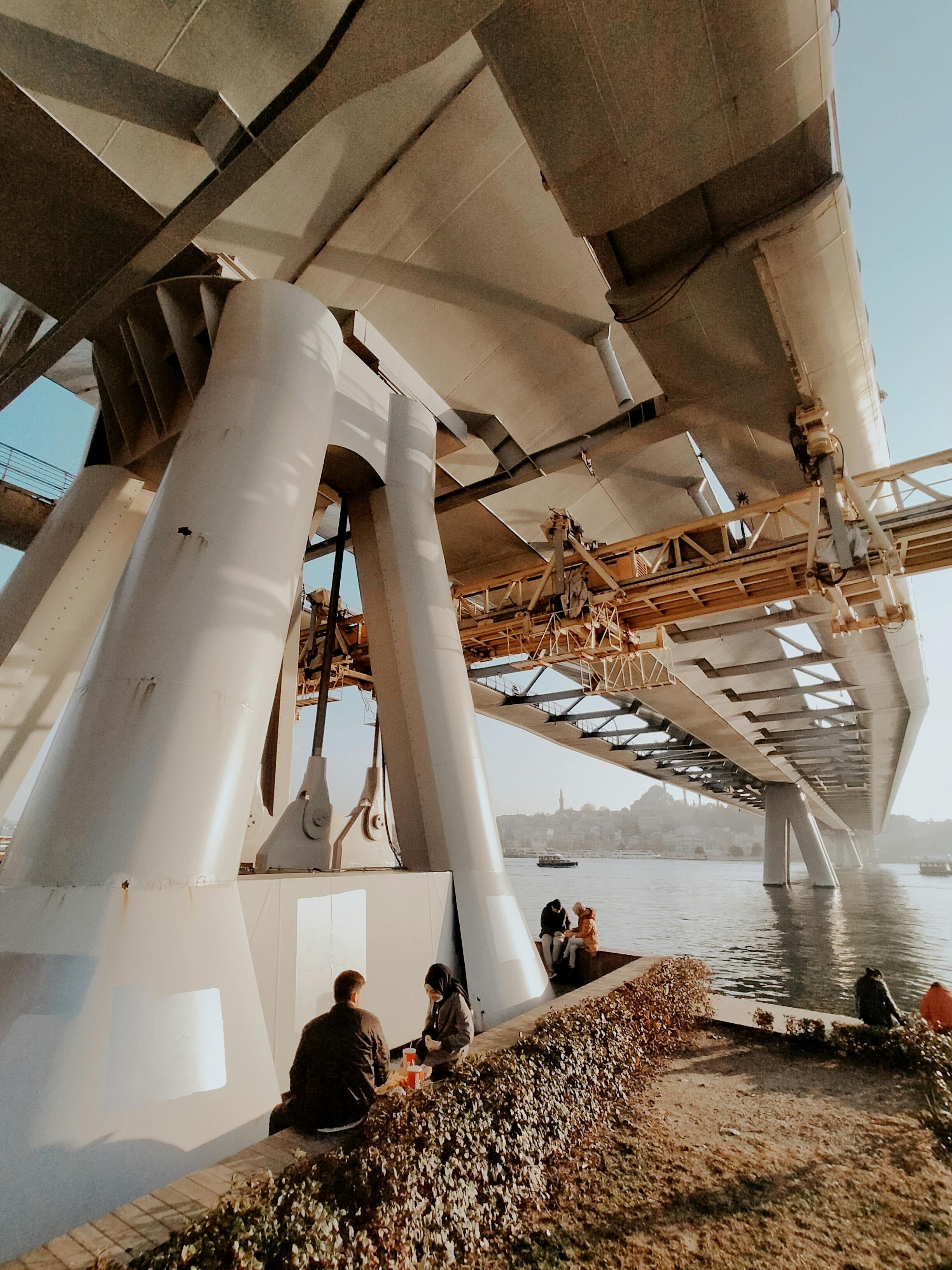 People Sitting Under a Bridge and Relaxing · Free Stock Photo