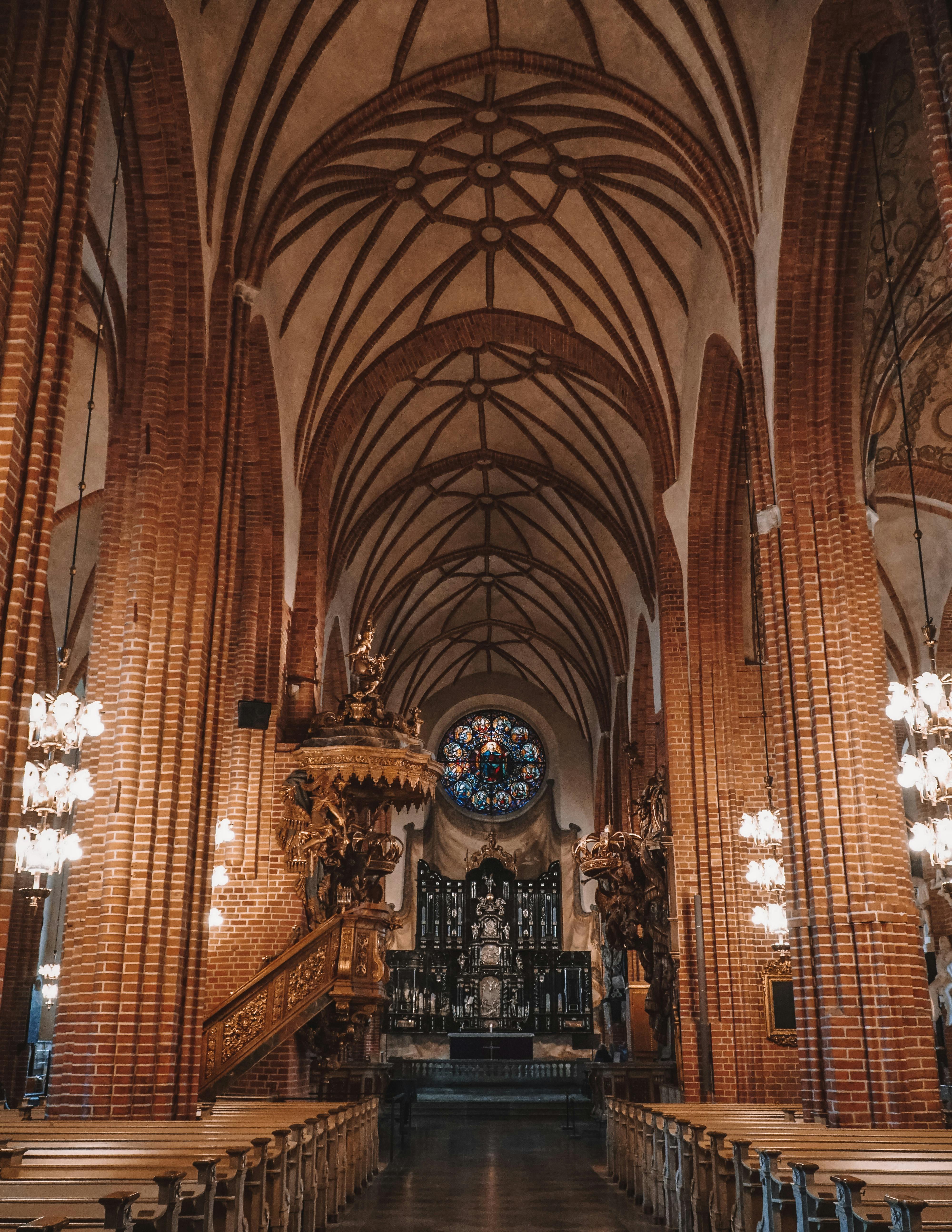 Symmetrical View of a Brick Church with Chandeliers and a Rosette ...