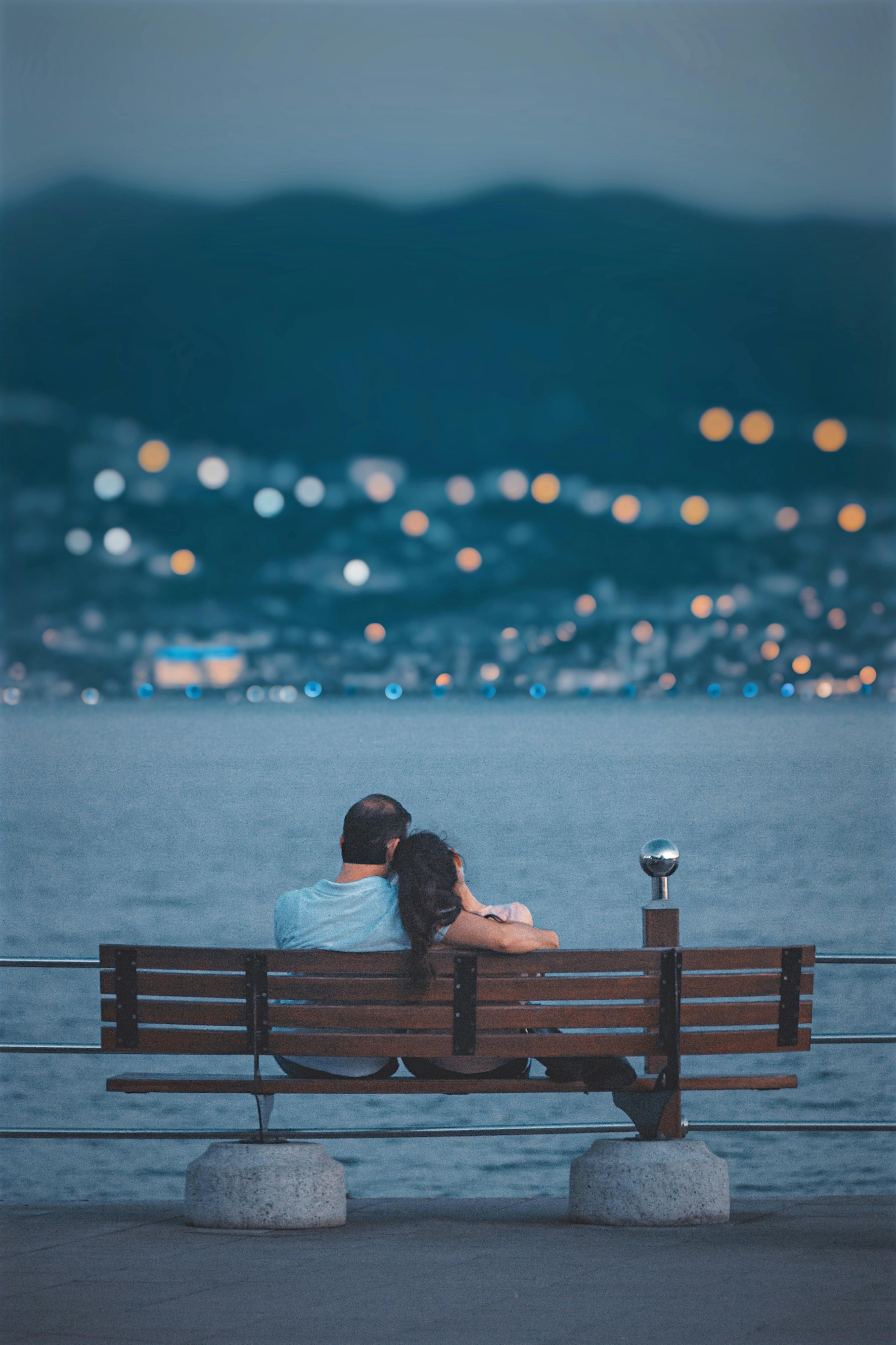 Back View of a Couple Sitting on a Bench Together · Free Stock Photo
