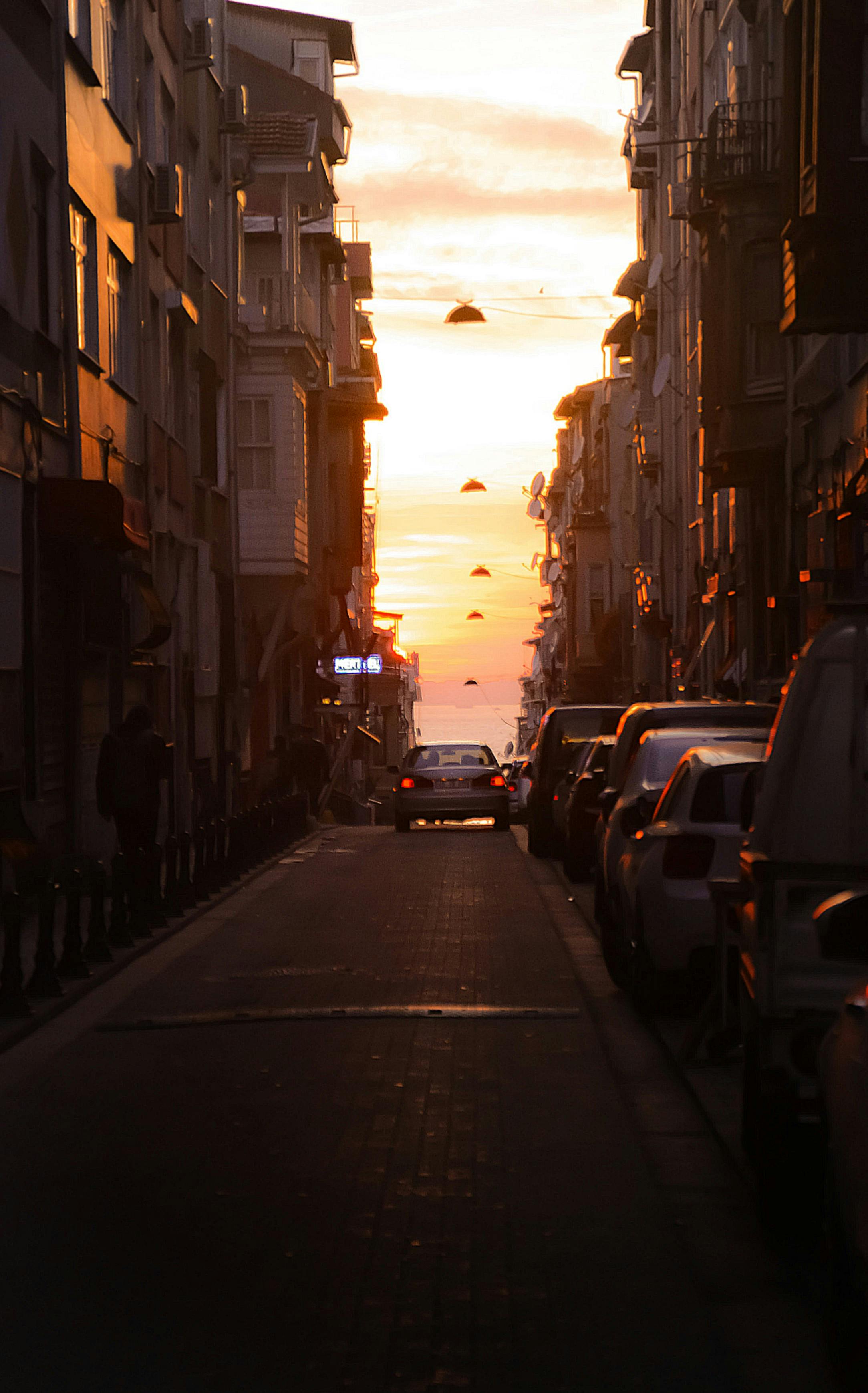 Photo of Cars Between Buildings During Sunset · Free Stock Photo