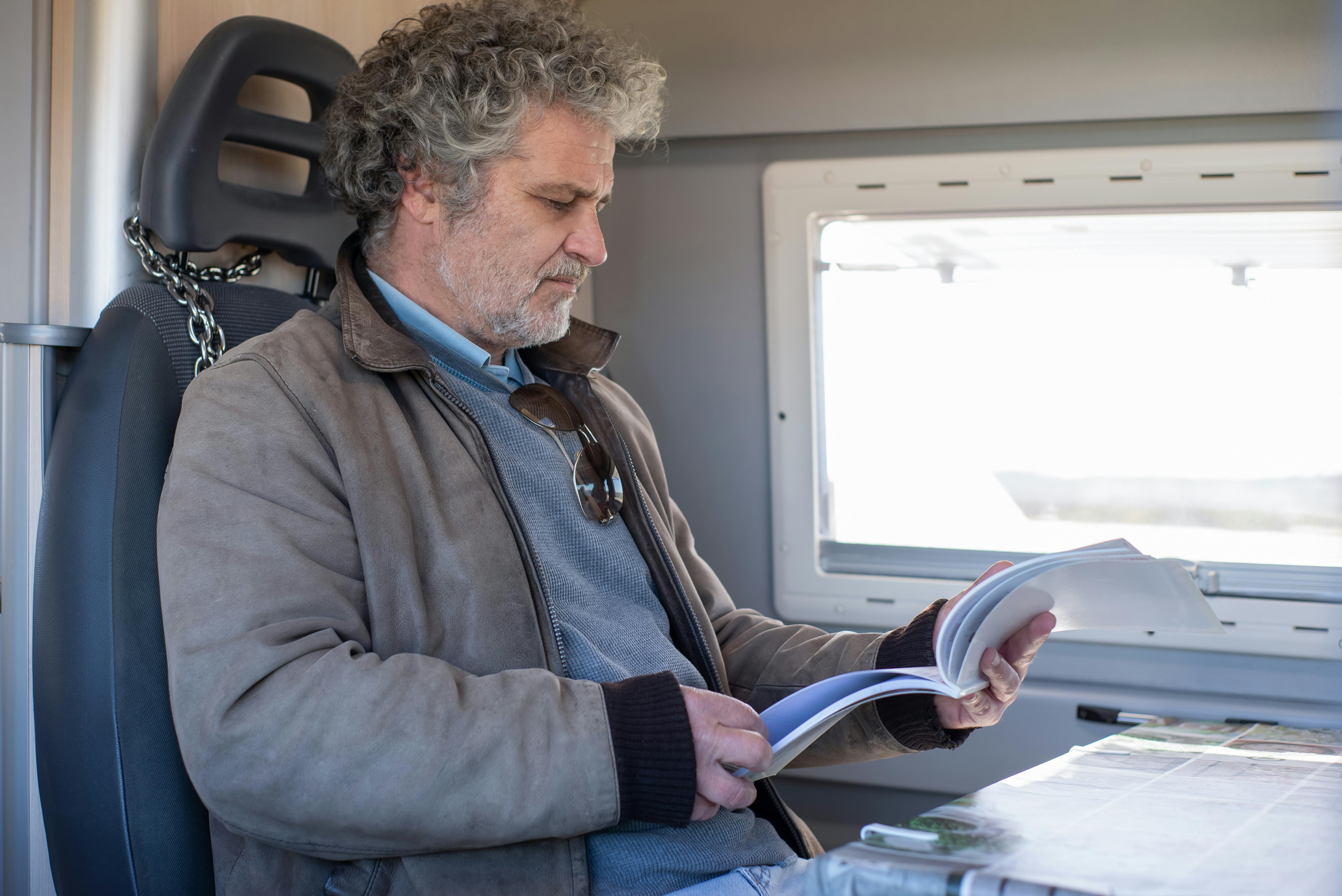 Man on the Train Reading · Free Stock Photo