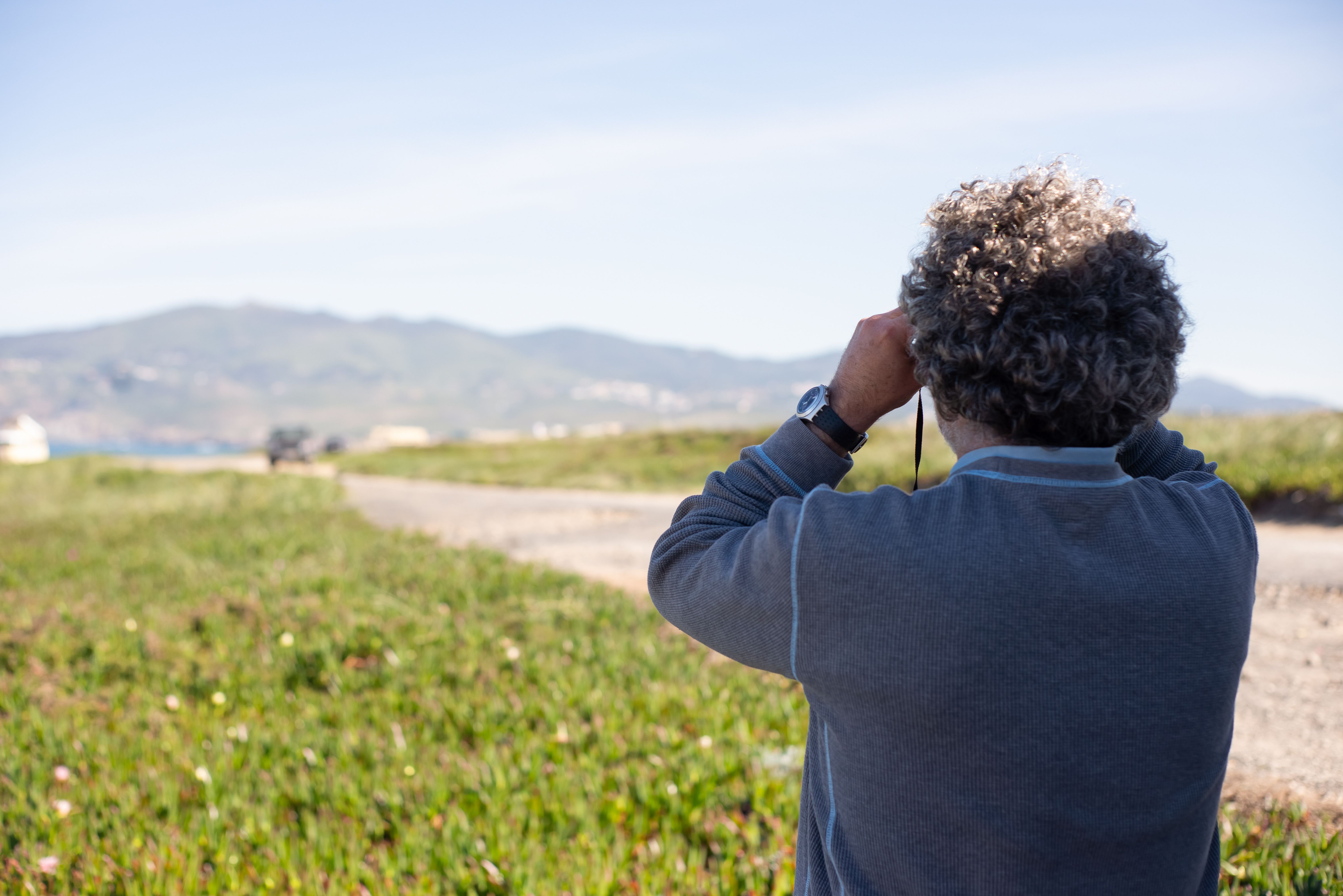 Back View of Man Holding the Hood of a Car · Free Stock Photo