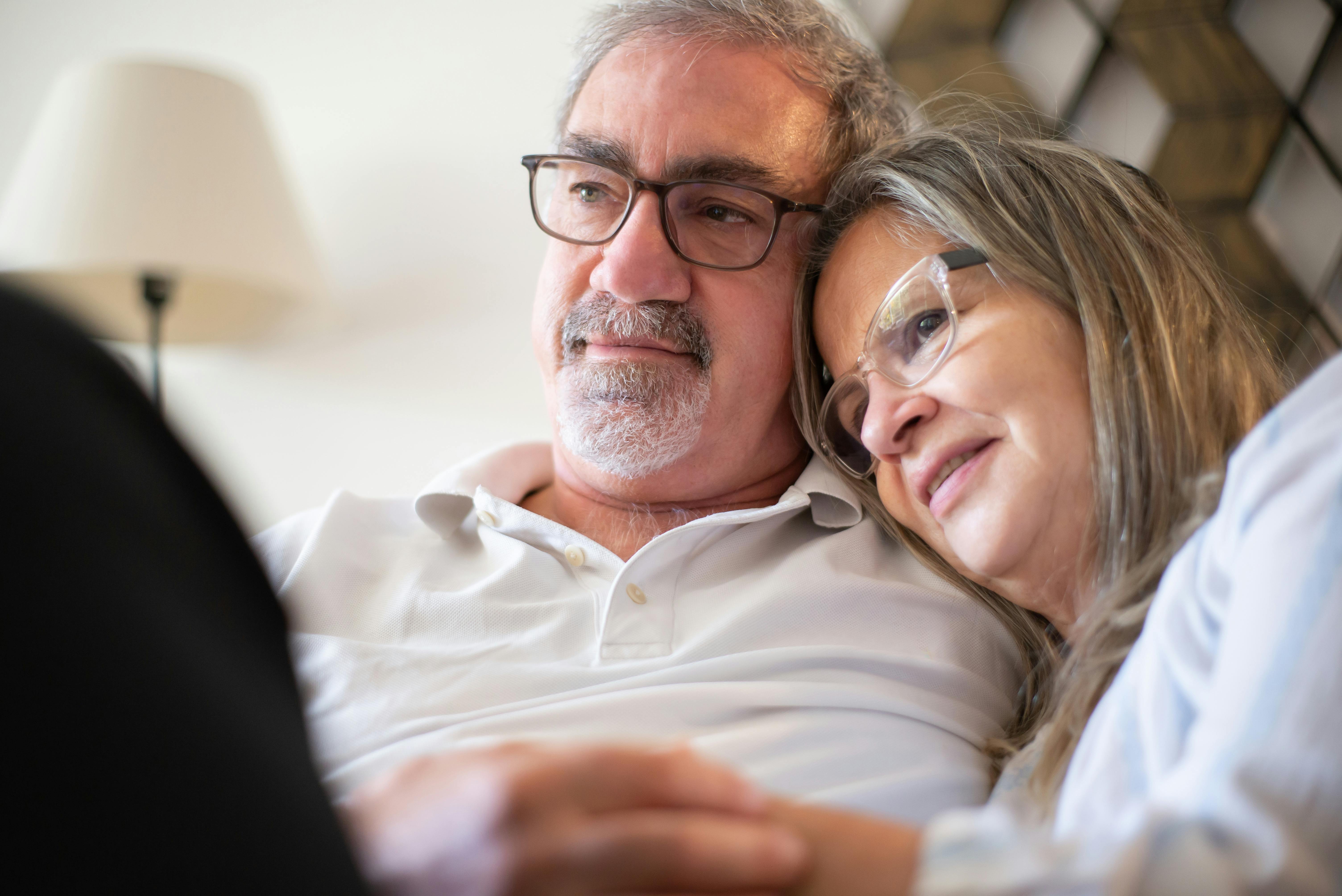 Woman Embracing a Man Sitting on a Chair · Free Stock Photo
