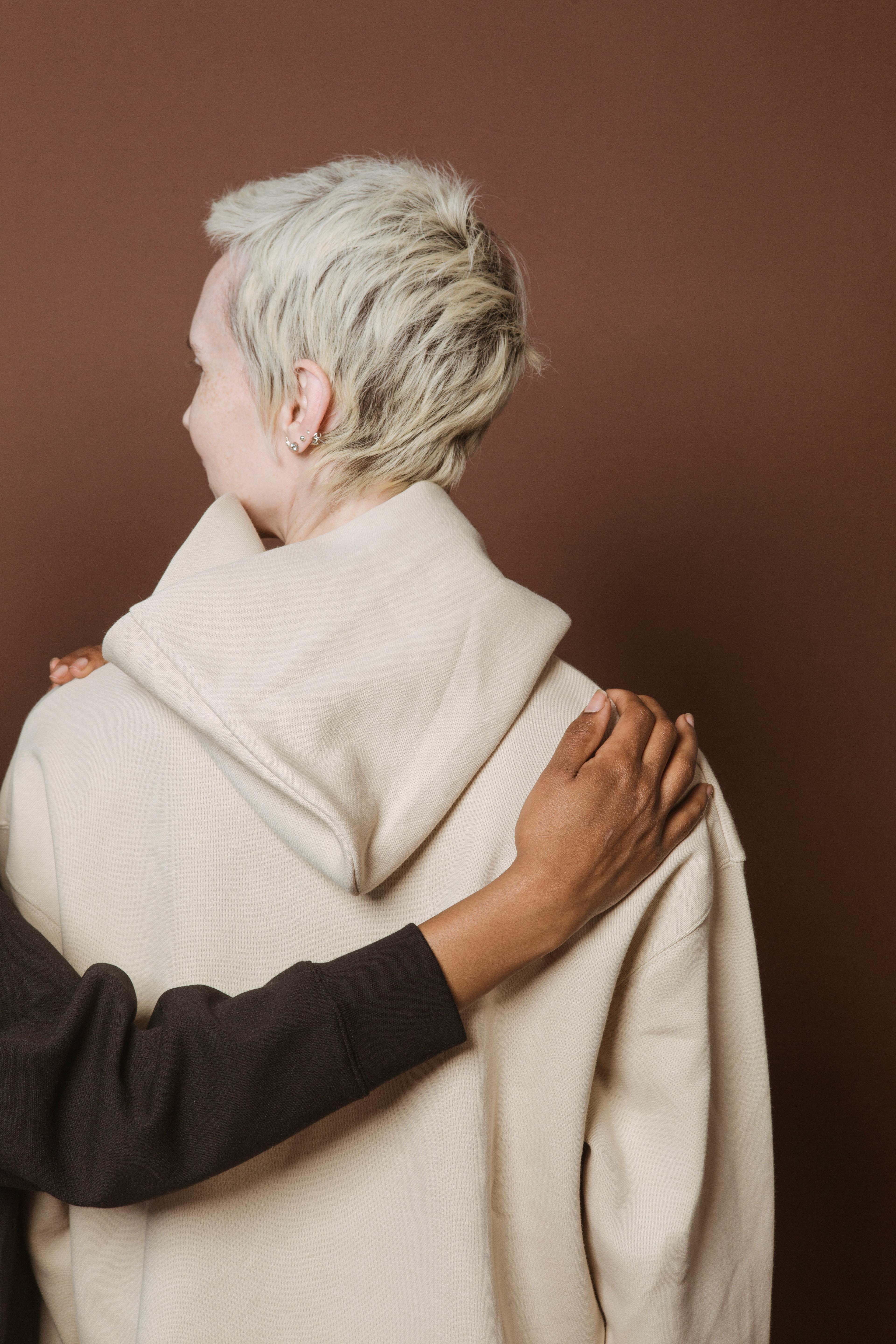 Black woman hugging back of female with short hair · Free Stock Photo