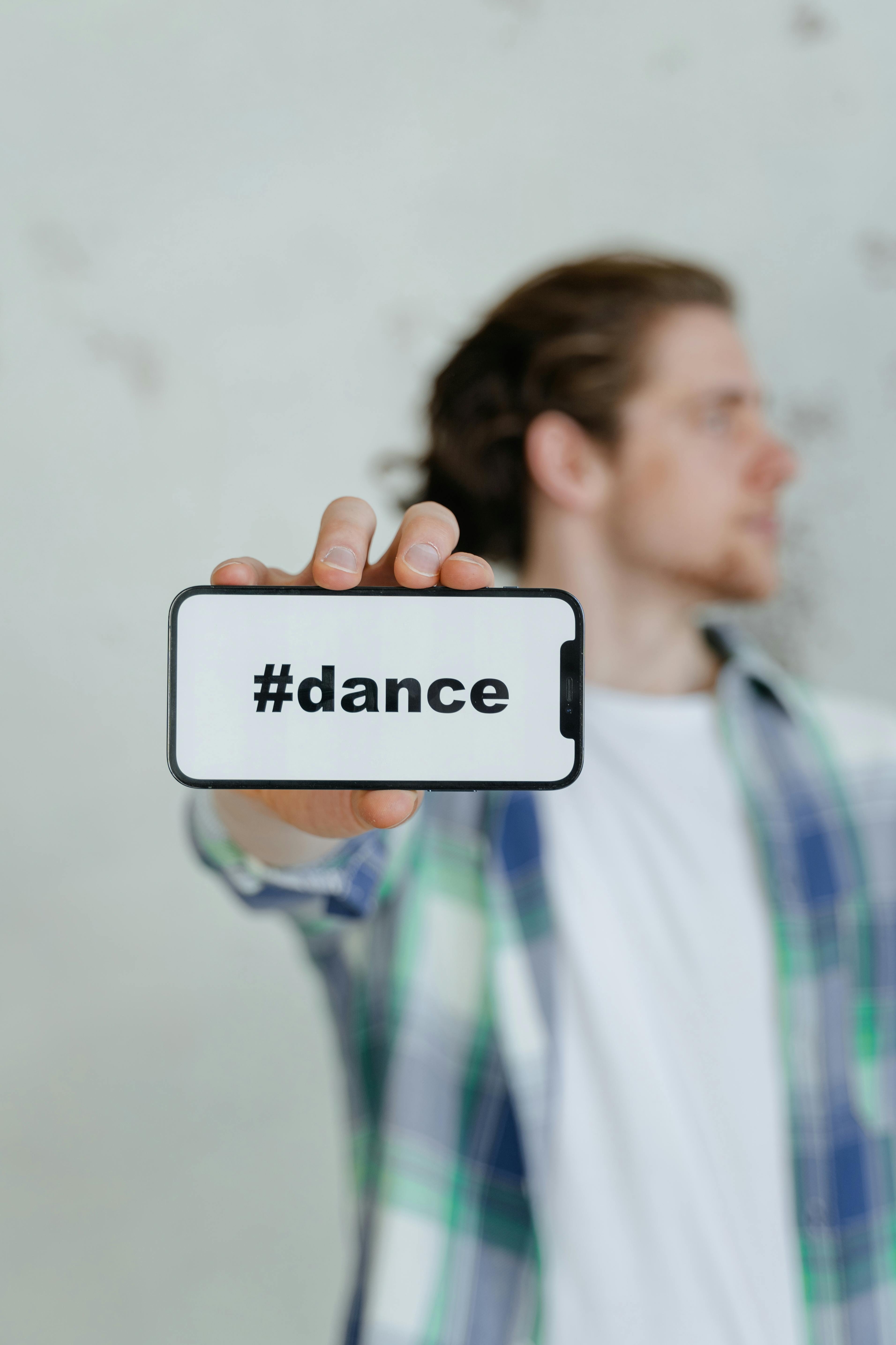 Person Holding Smartphone with Hashtag Dance · Free Stock Photo