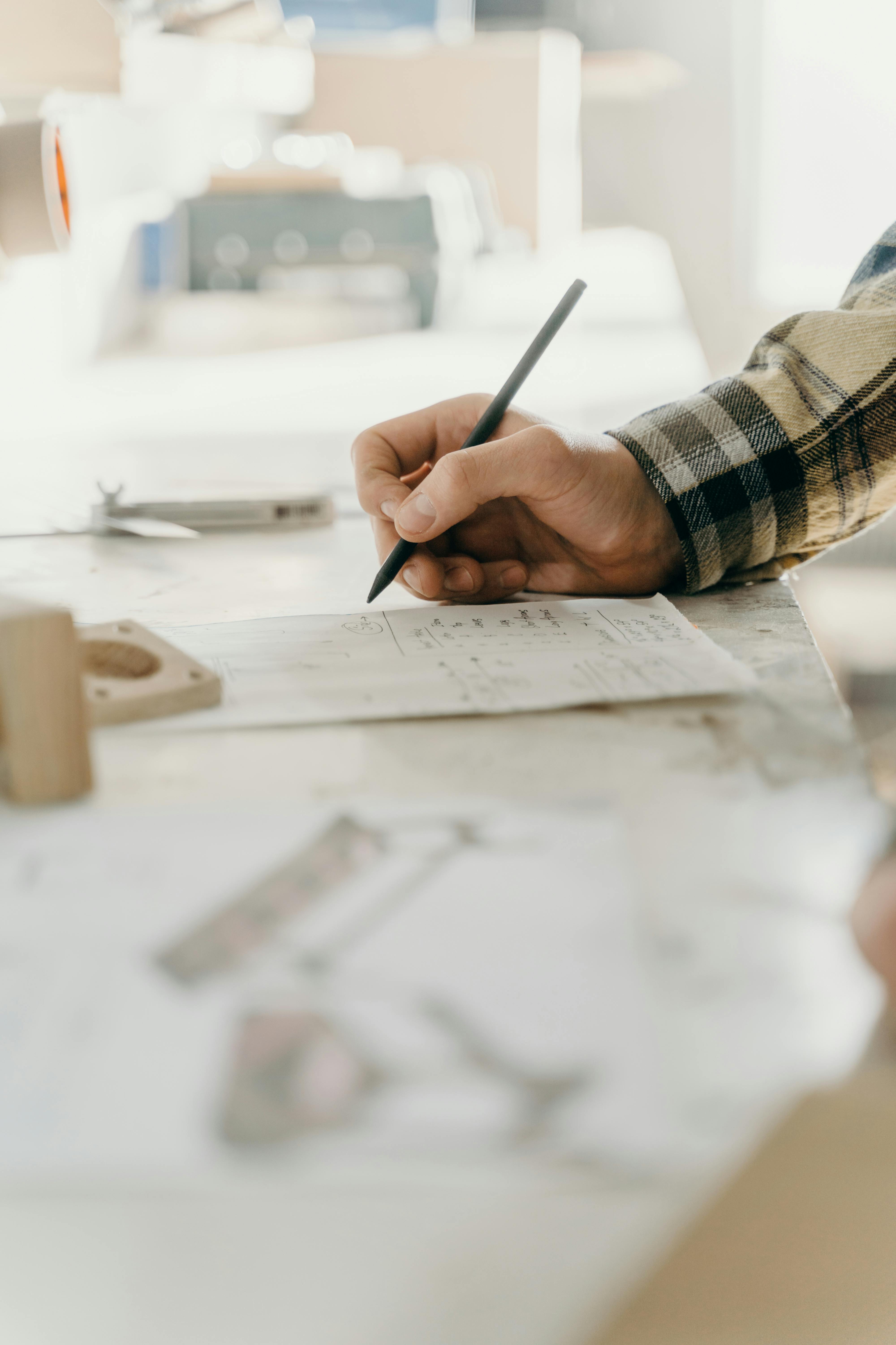 Person Writing on White Paper · Free Stock Photo