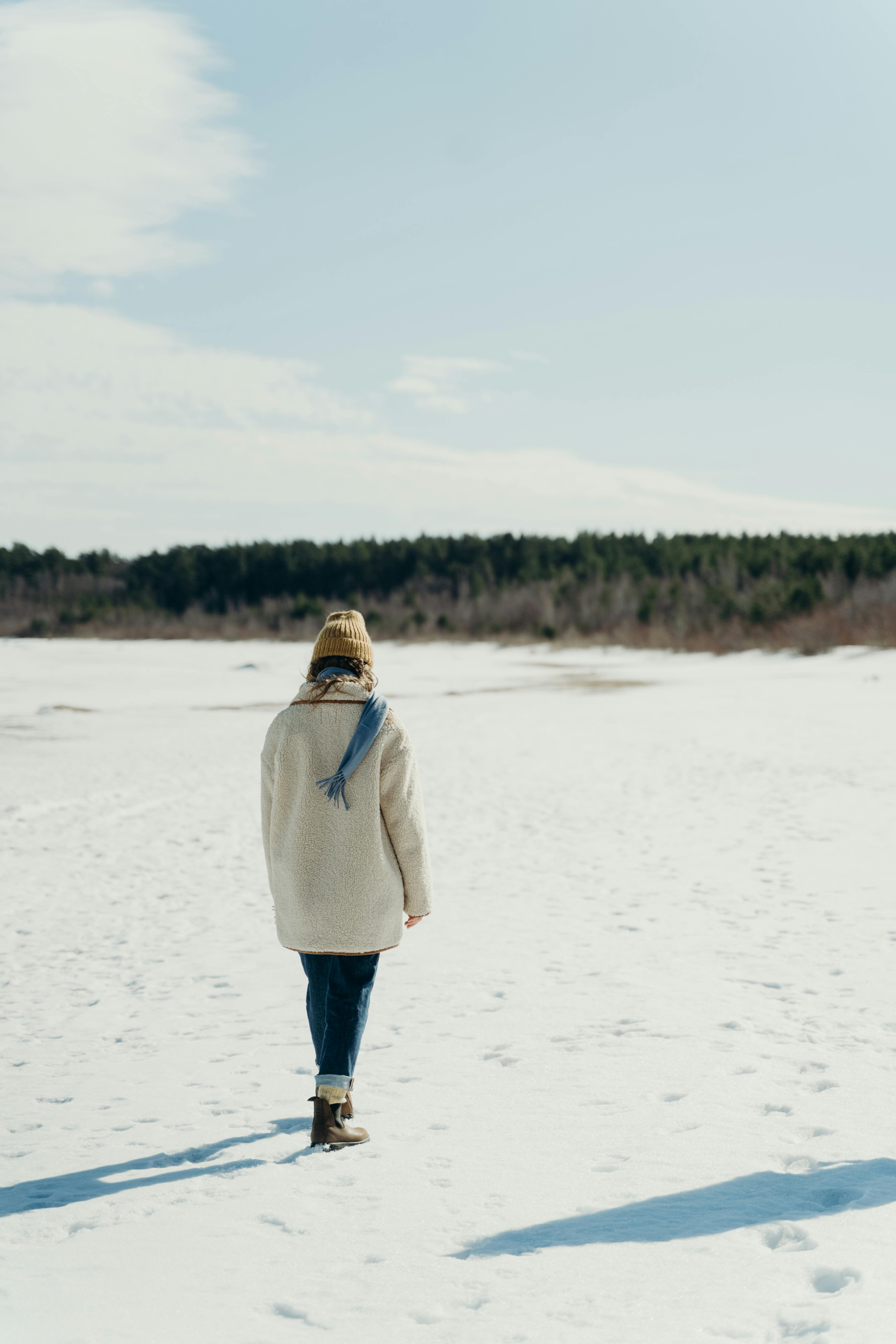 Woman in Brown Coat Lying on Snow · Free Stock Photo