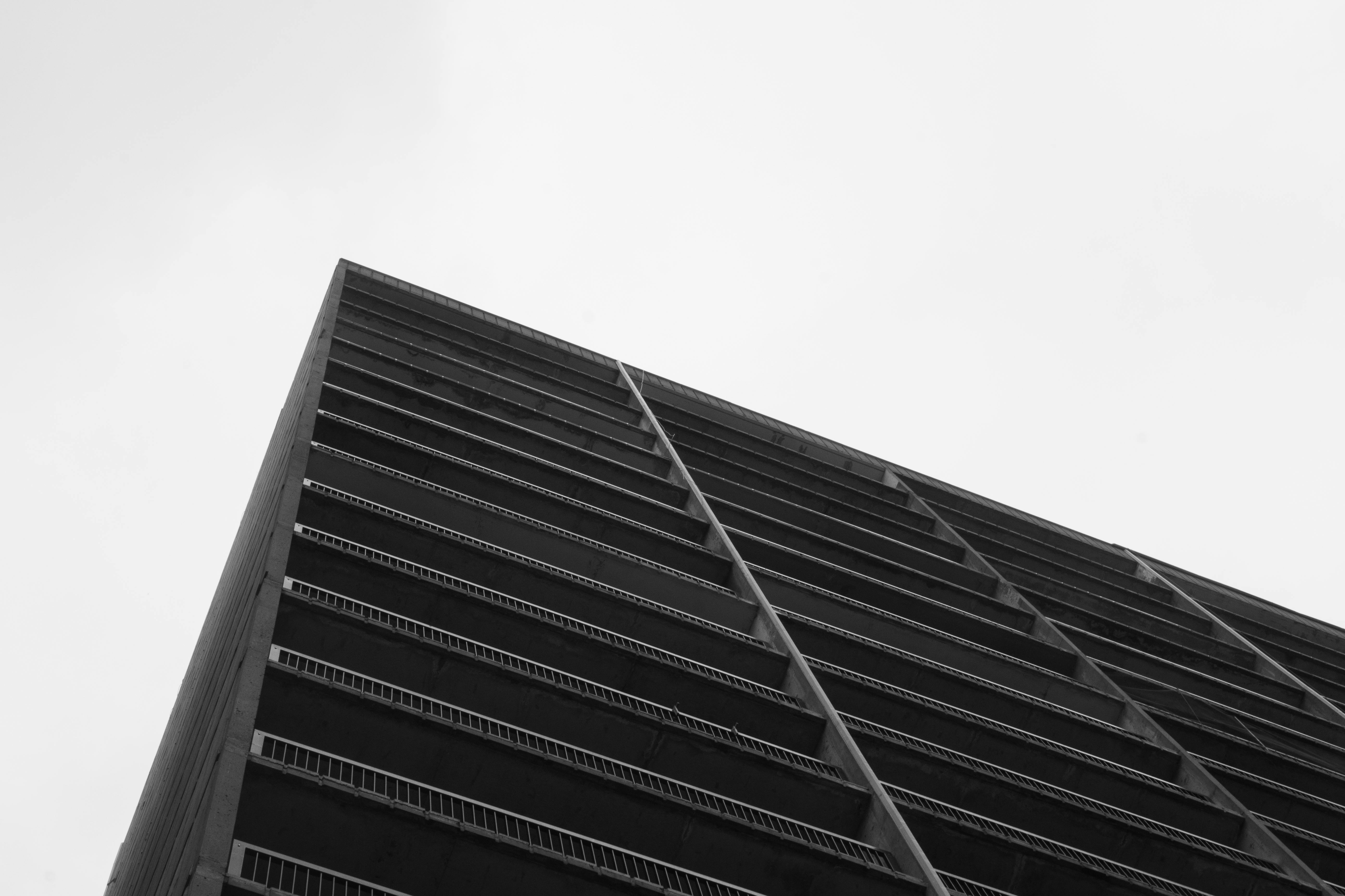 Grayscale Photo of High Rise Buildings Under Clear Sky · Free Stock Photo