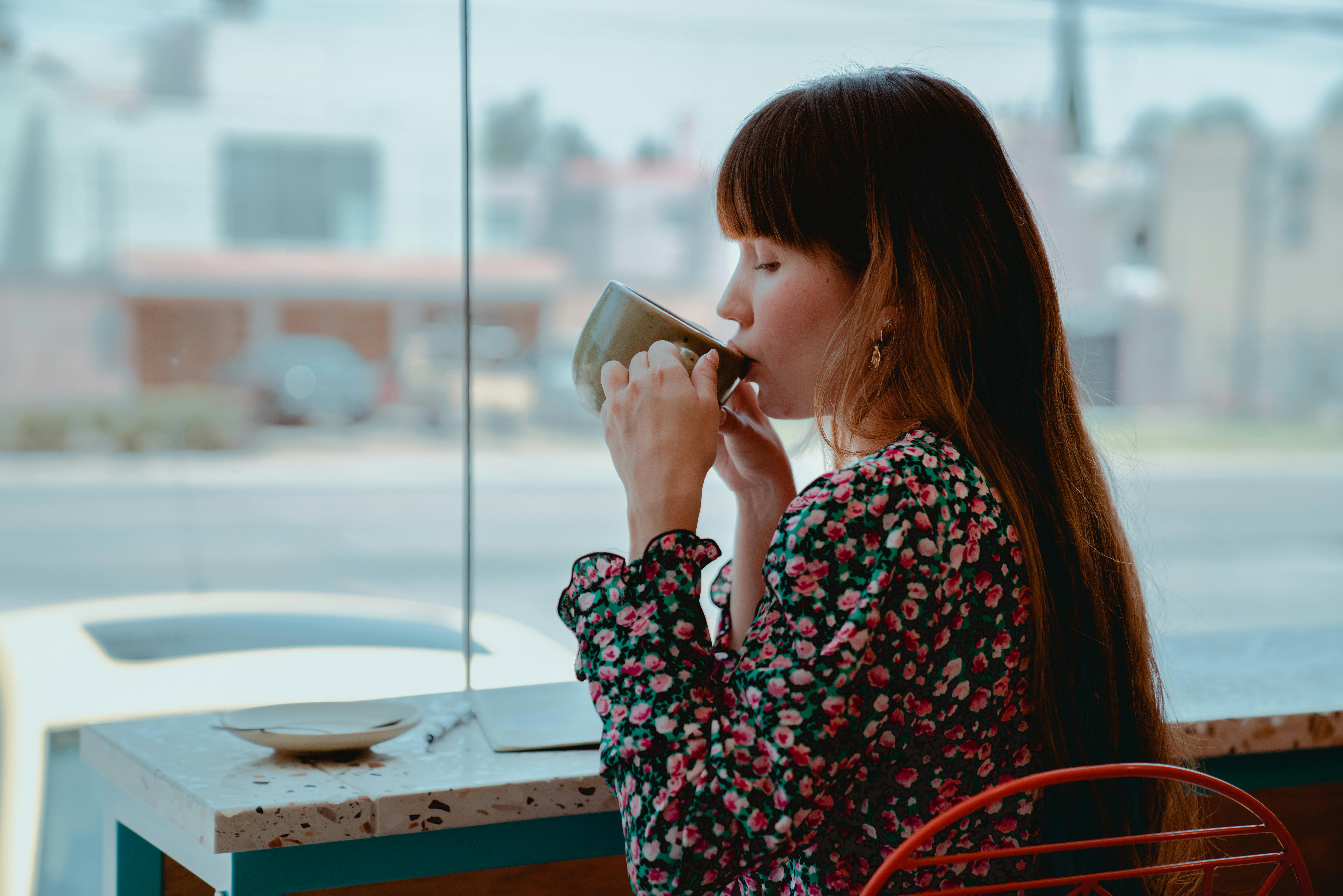 Photo of Woman Sipping Coffee · Free Stock Photo