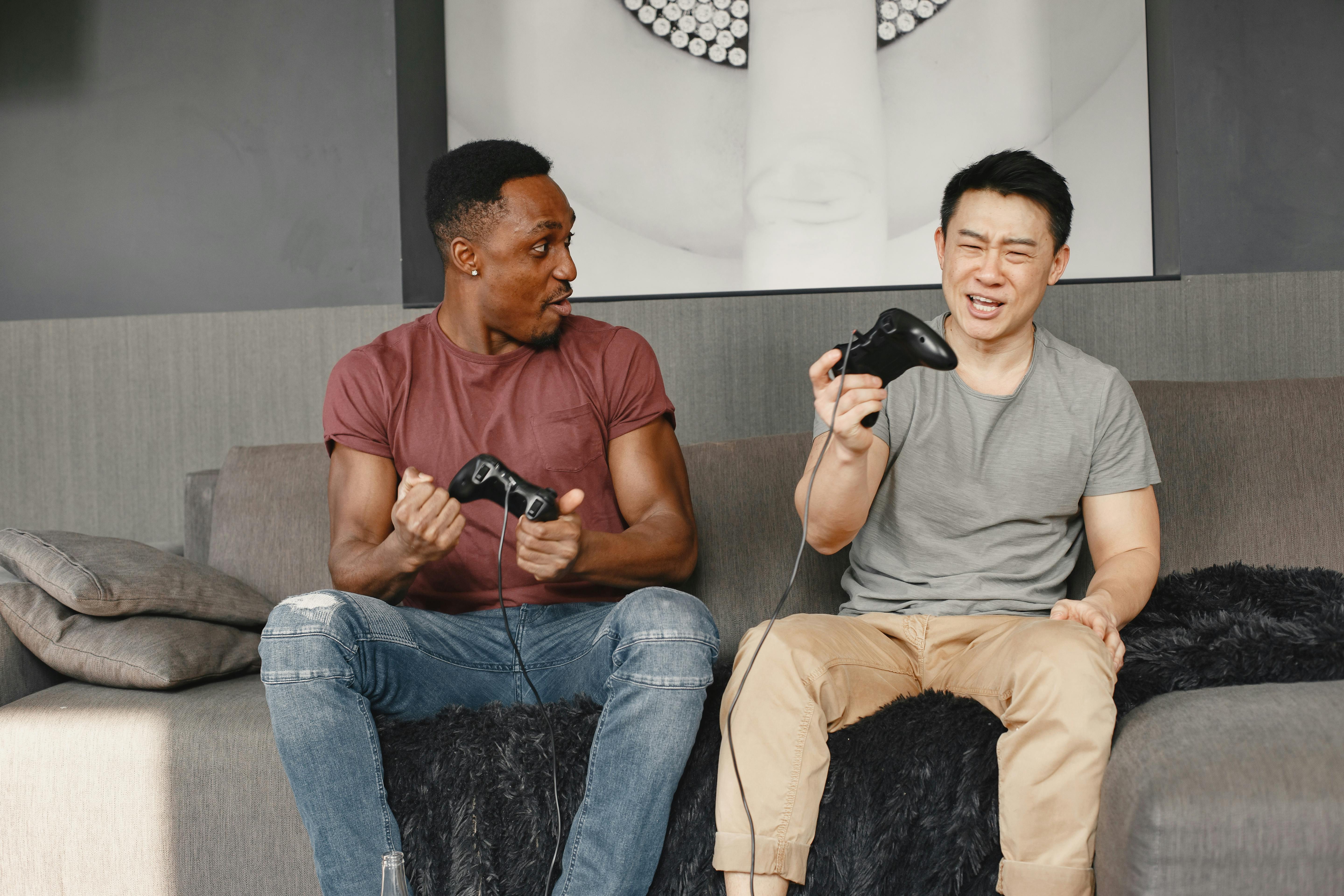 Men Holding Game Controllers · Free Stock Photo
