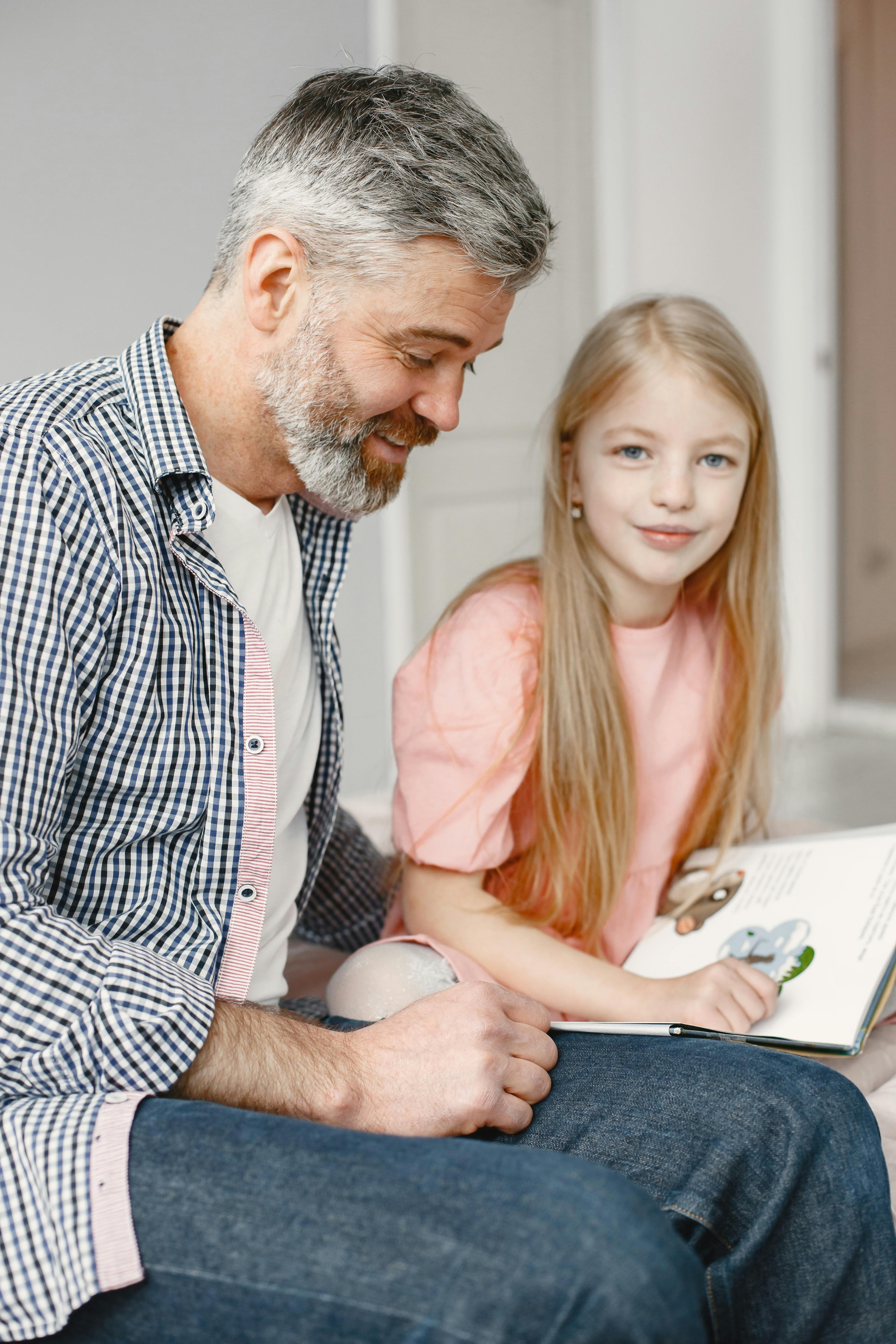 Girl Reading a Book with Her Dad · Free Stock Photo