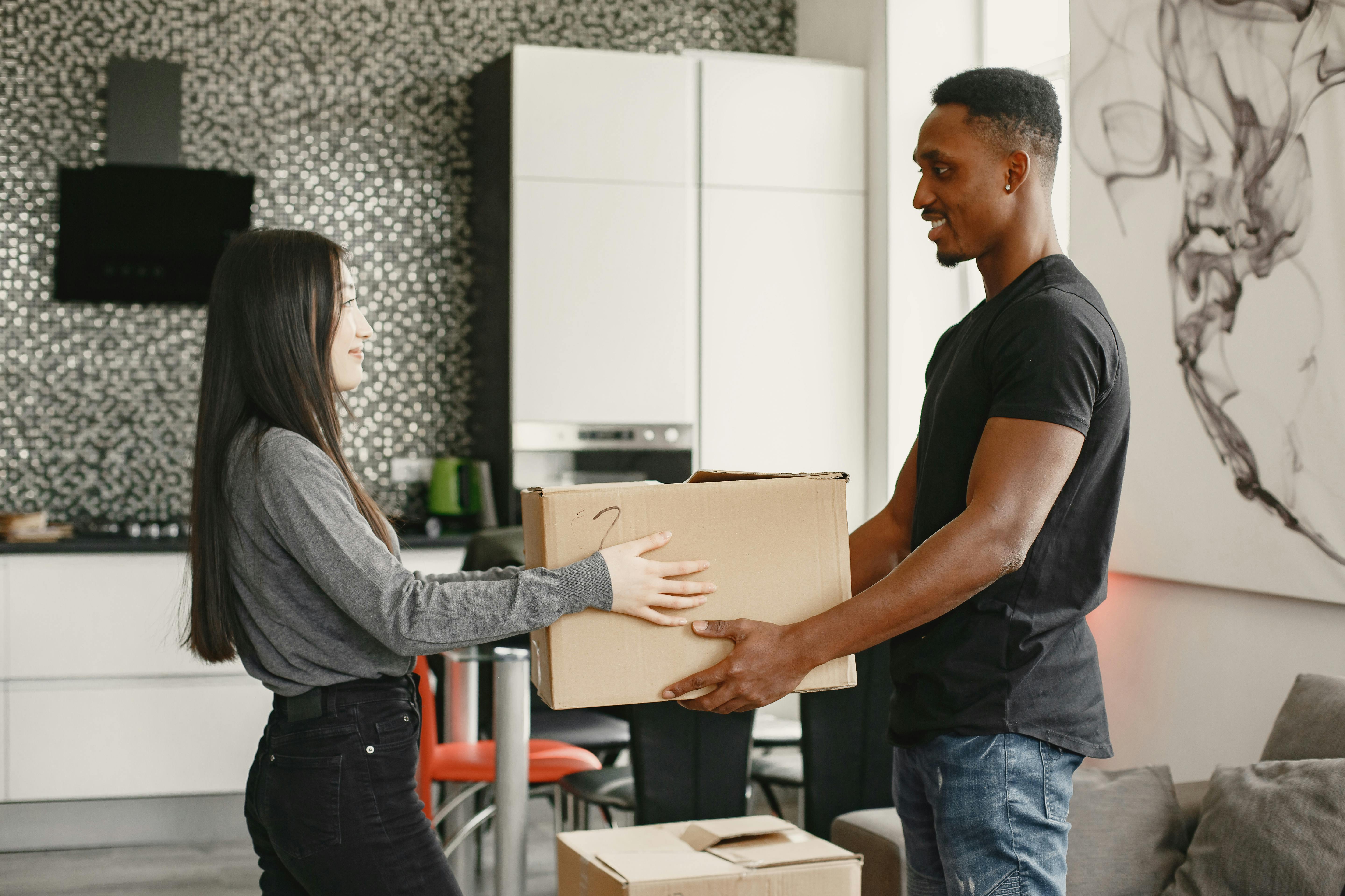 A Couple Carrying a Box · Free Stock Photo