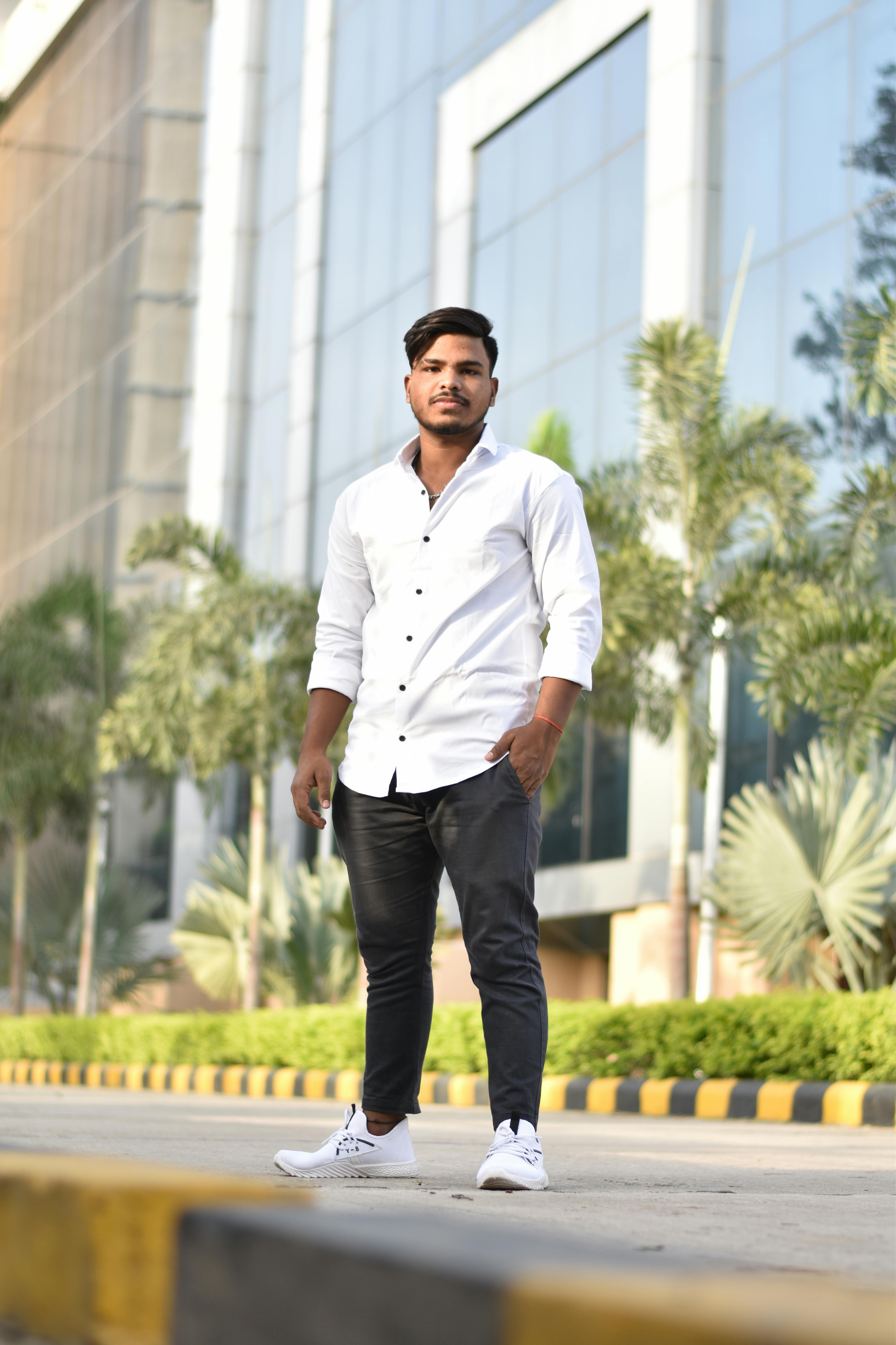 A Man Posing while Leaning on Metal Railings · Free Stock Photo