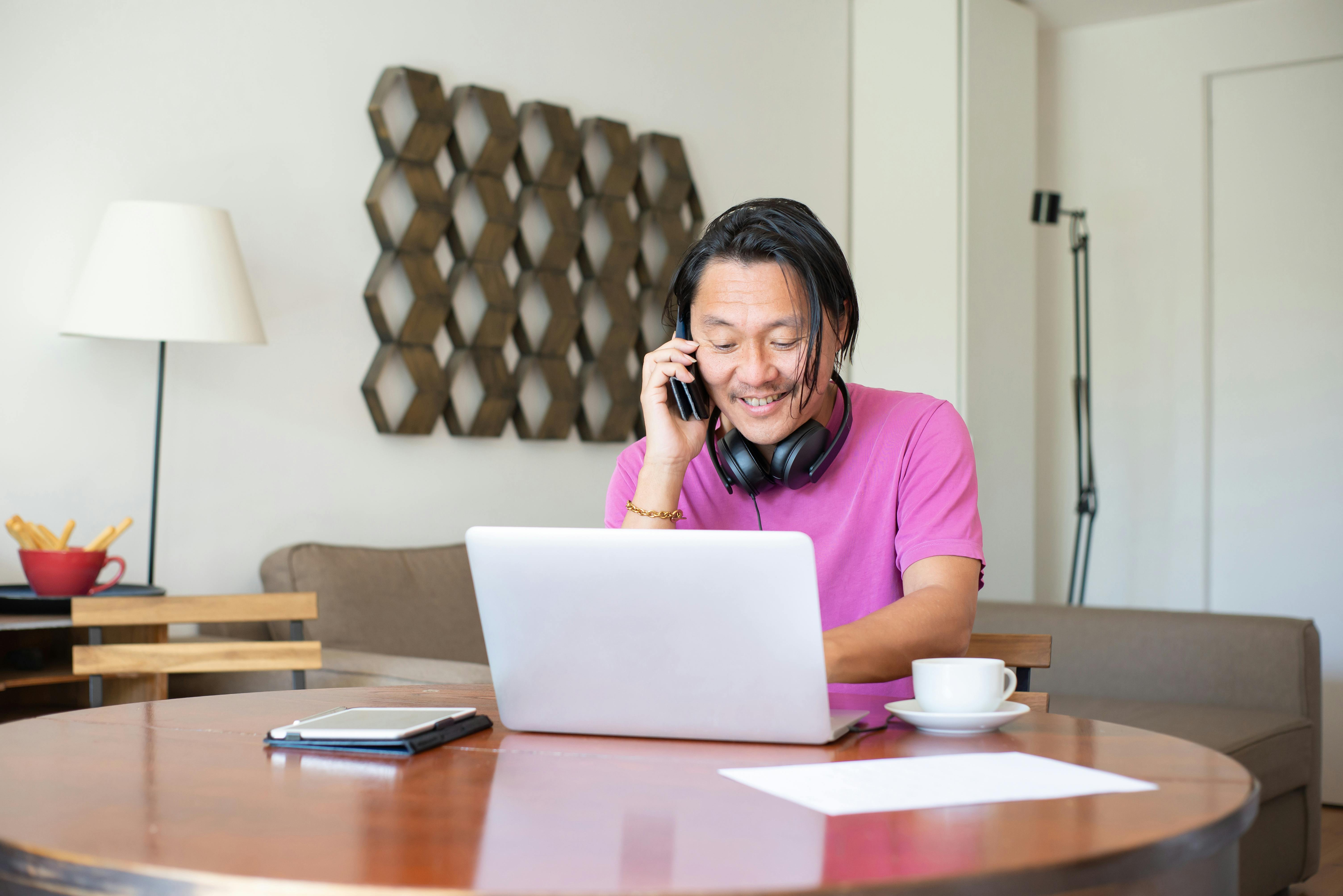 Man in White Shirt Using Laptop Computer · Free Stock Photo