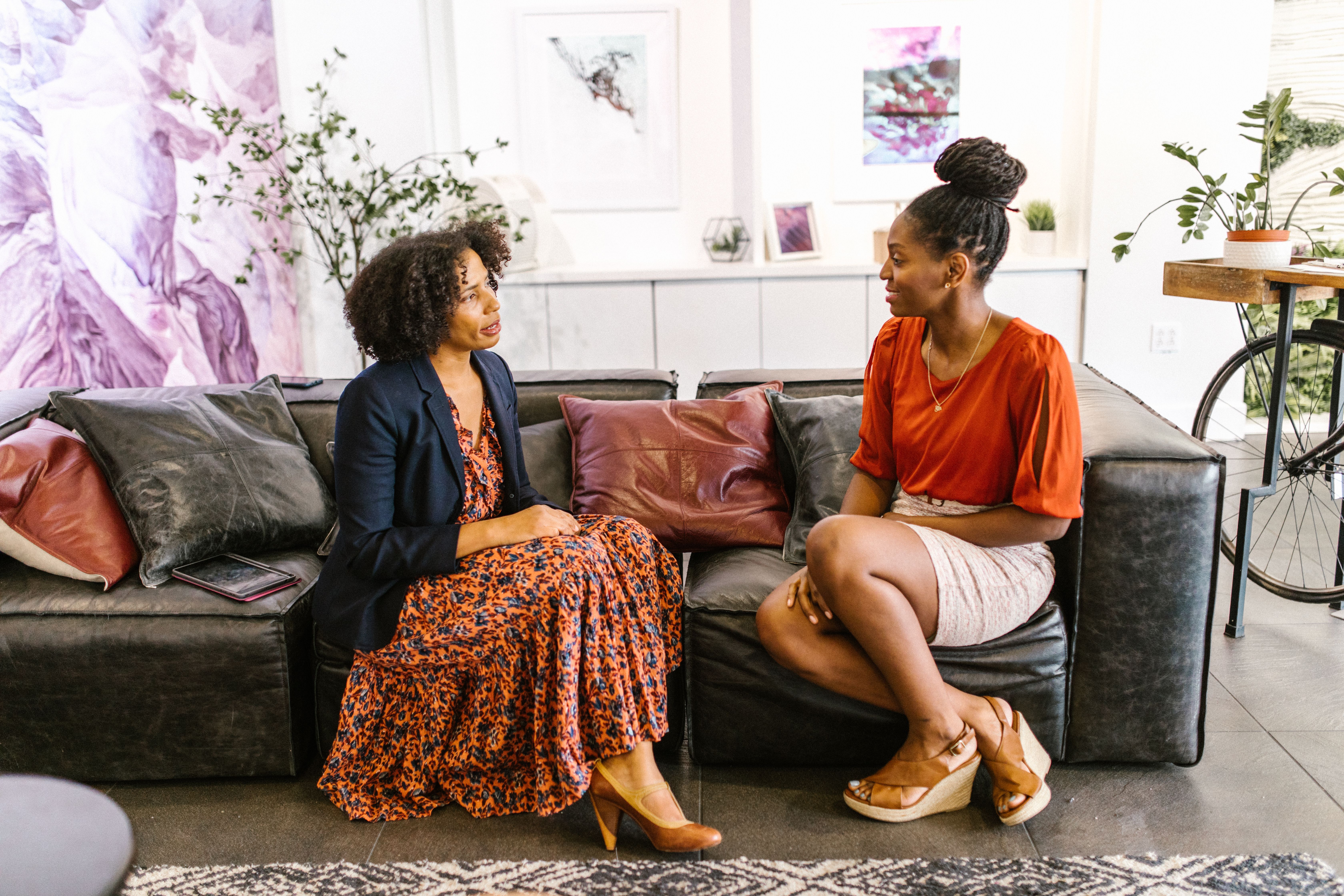 Women Sitting on a Black Leather Sofa Having a Conversation · Free ...