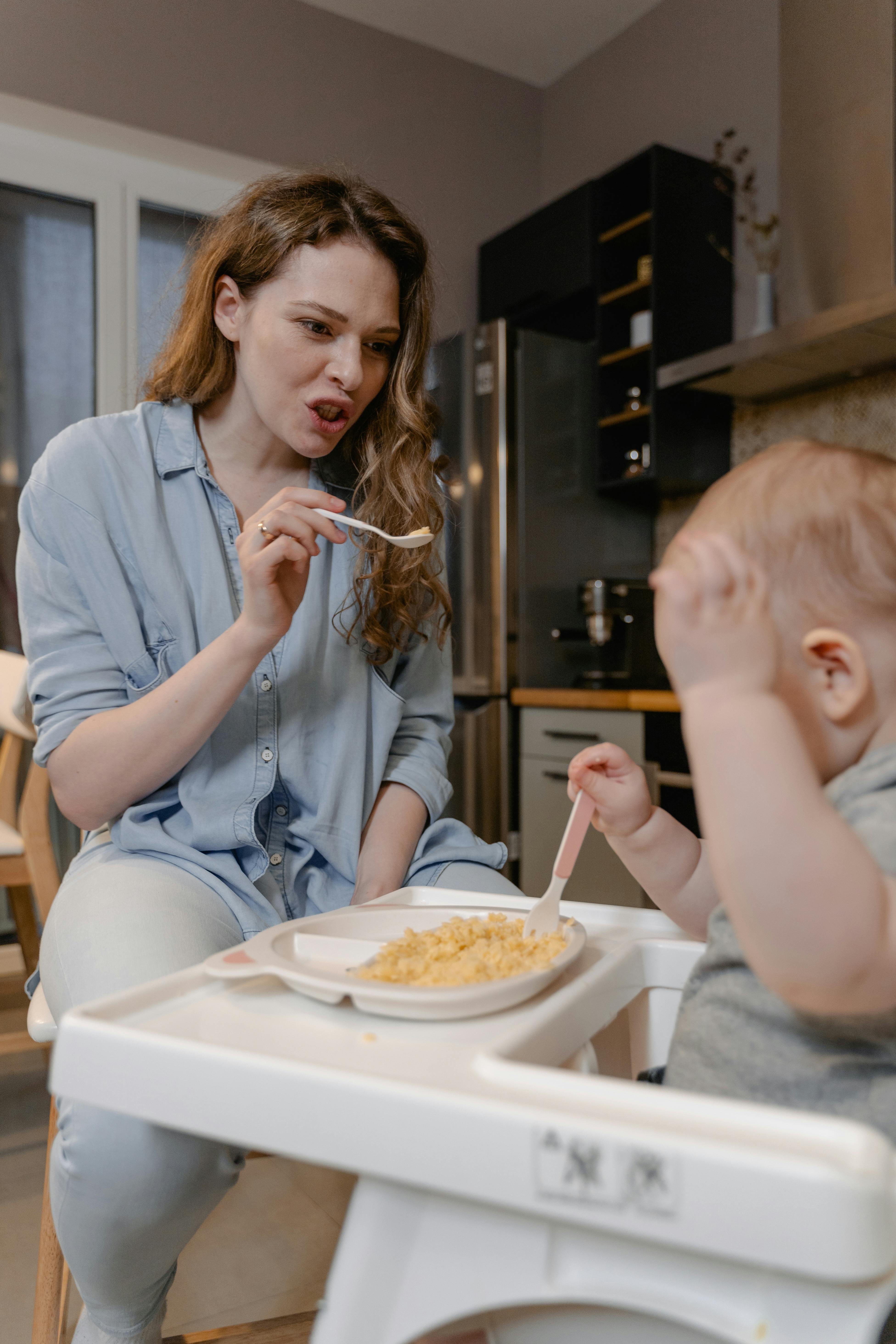 A Woman Feeding Her Child · Free Stock Photo