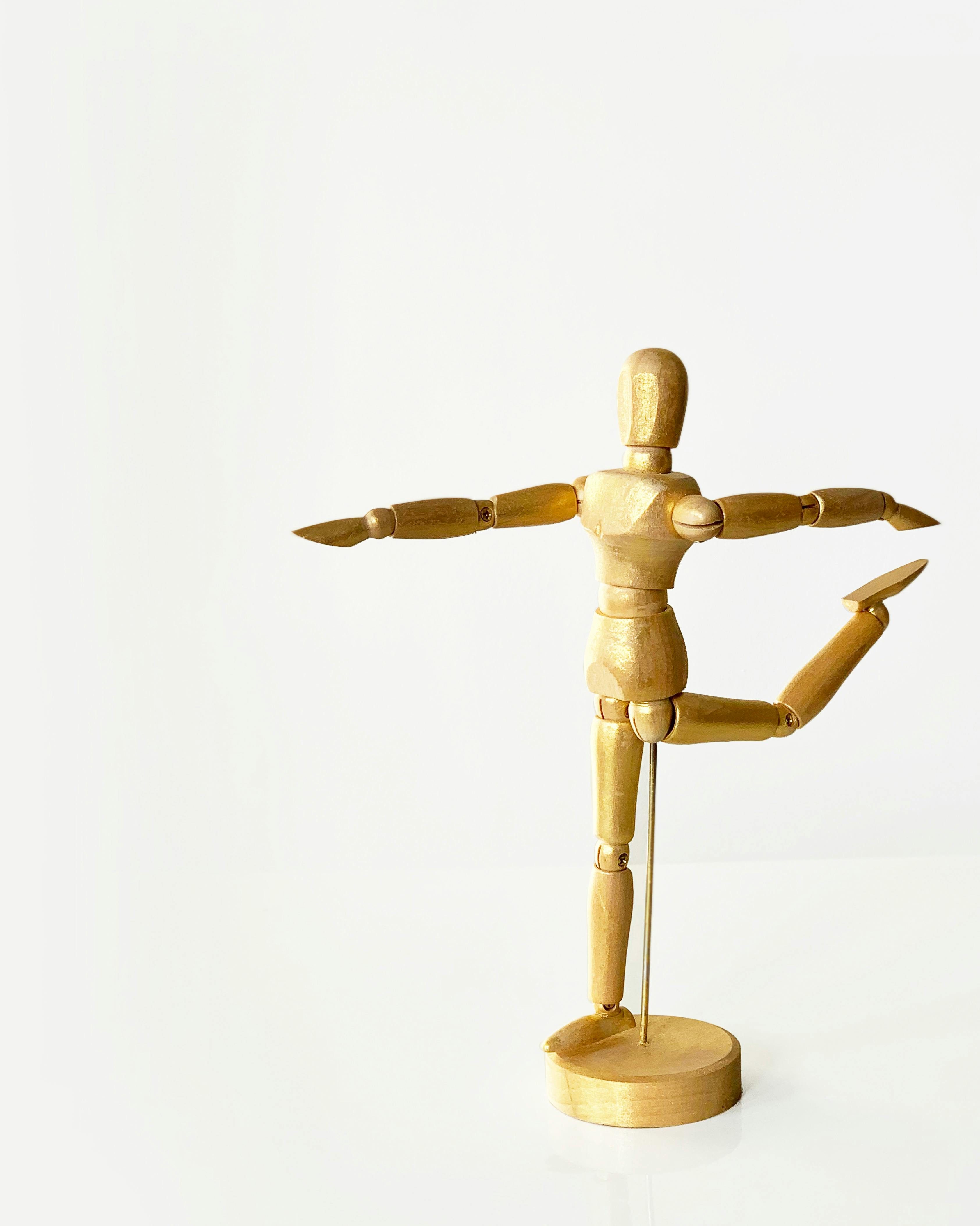 Brown Wooden Human Figure on White Table · Free Stock Photo
