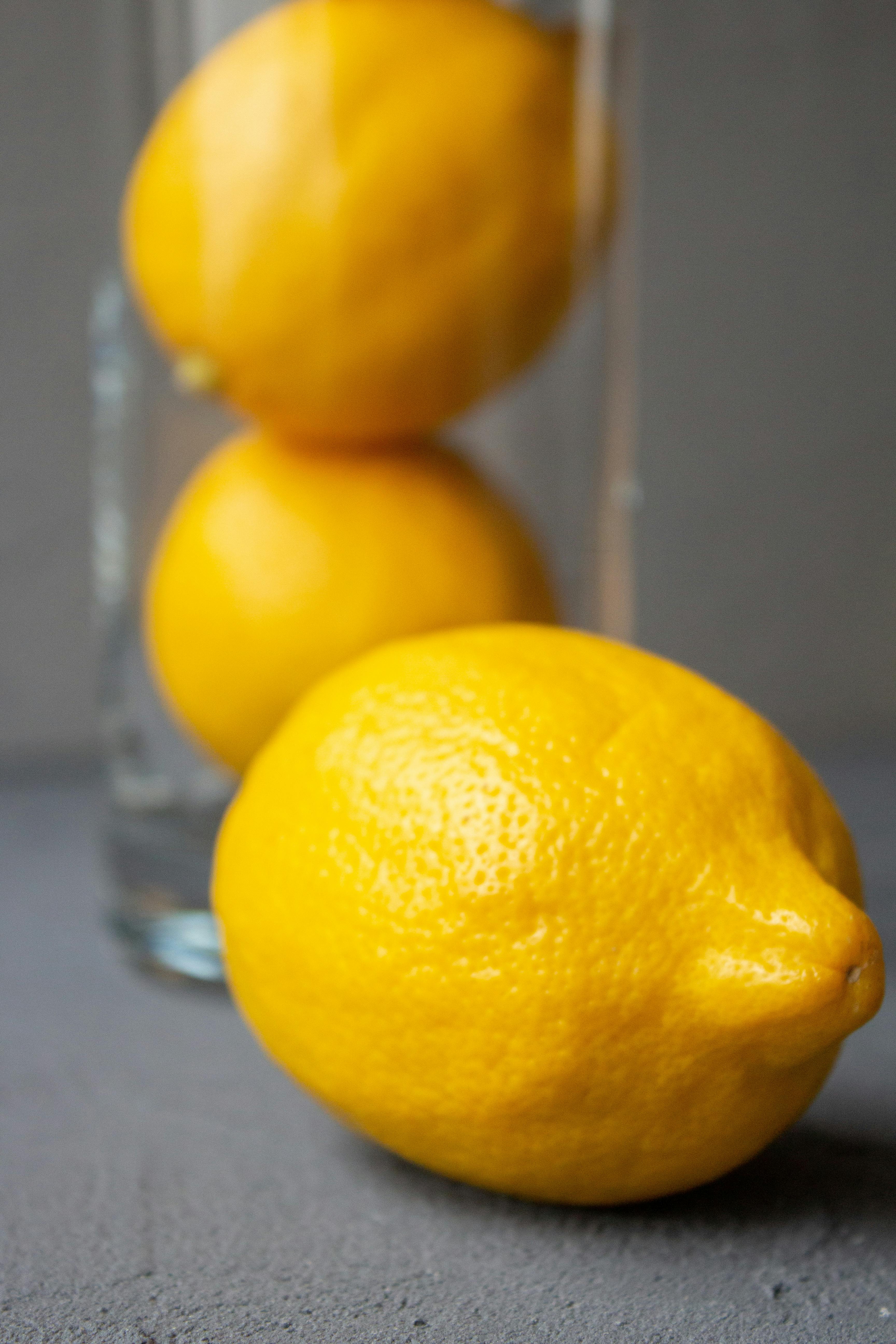 Juicy raw lemons placed on gray table · Free Stock Photo