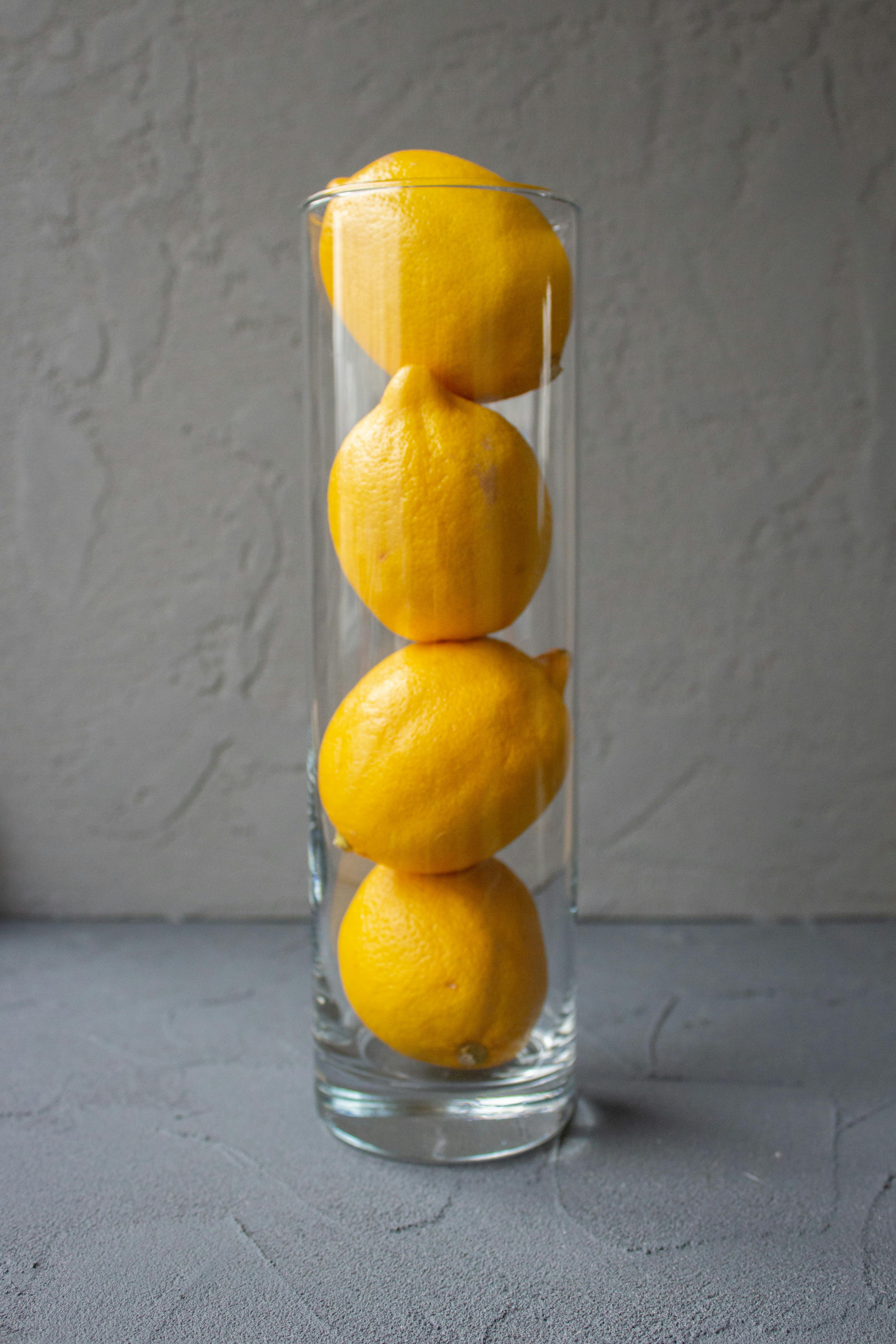 Heap of yellow lemons scattered on gray surface · Free Stock Photo