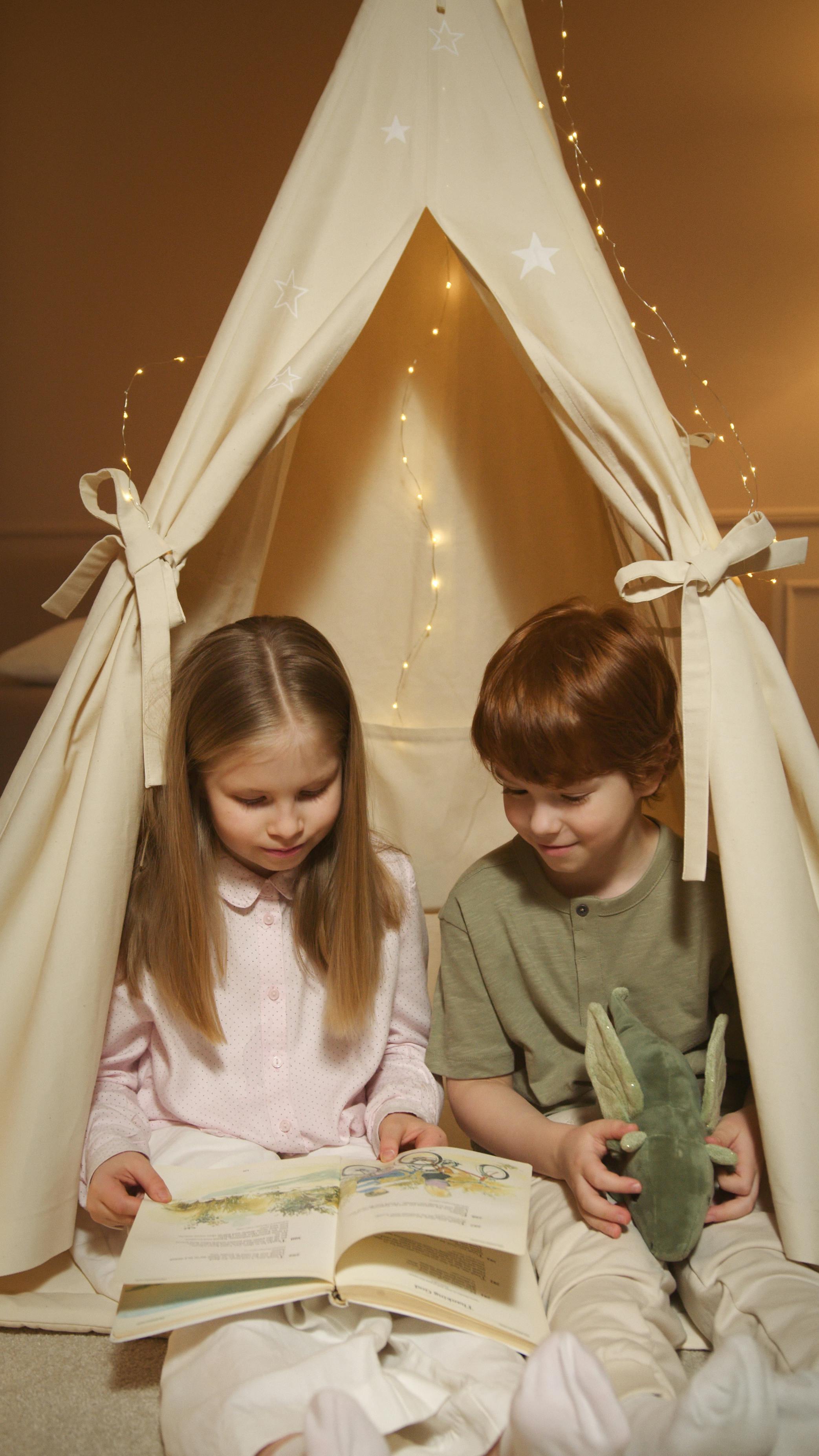 Two Children Sitting inside the Tent · Free Stock Photo