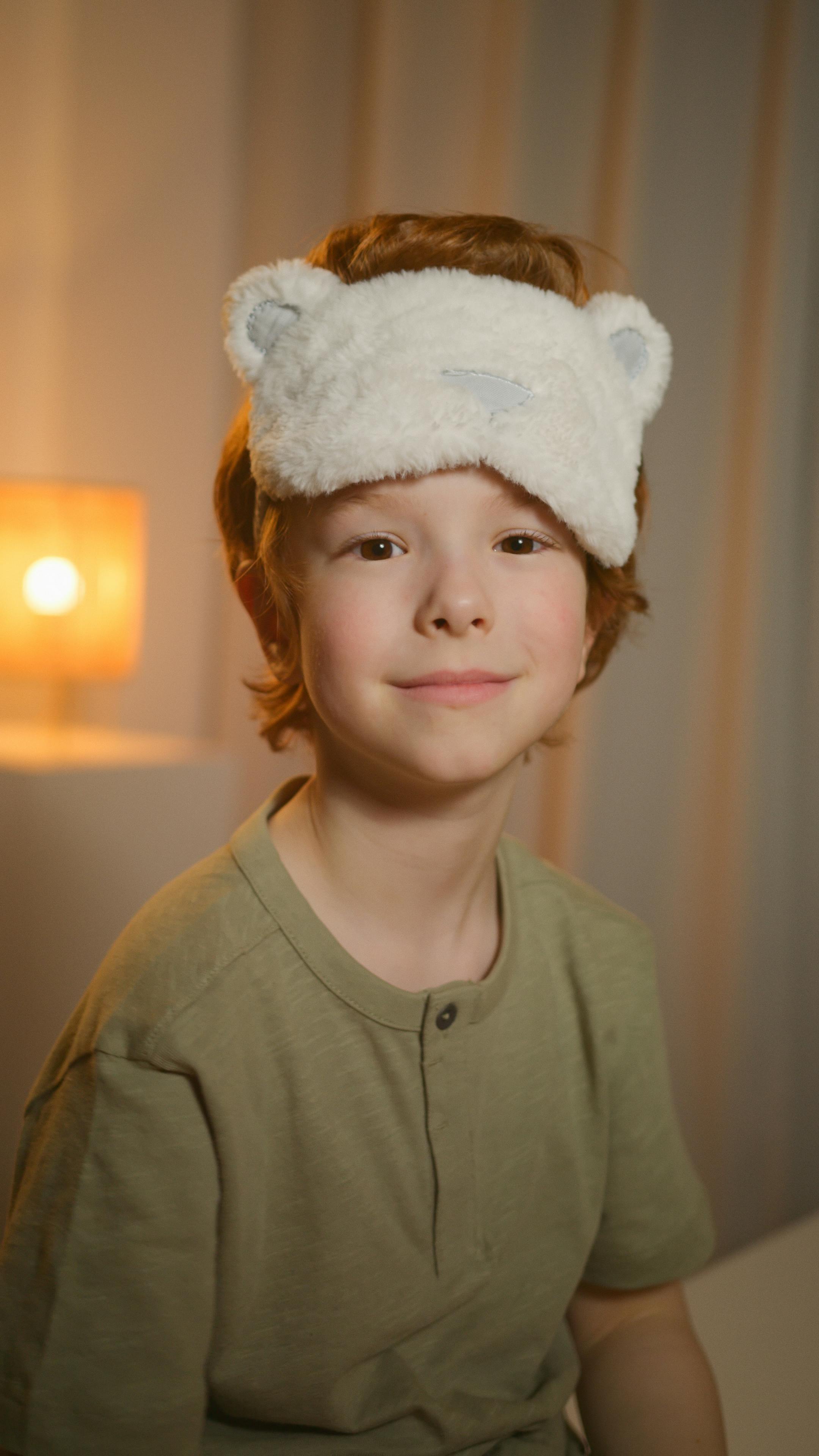 Photo of a Boy with a Sleep Mask Wearing a Green Shirt · Free Stock Photo