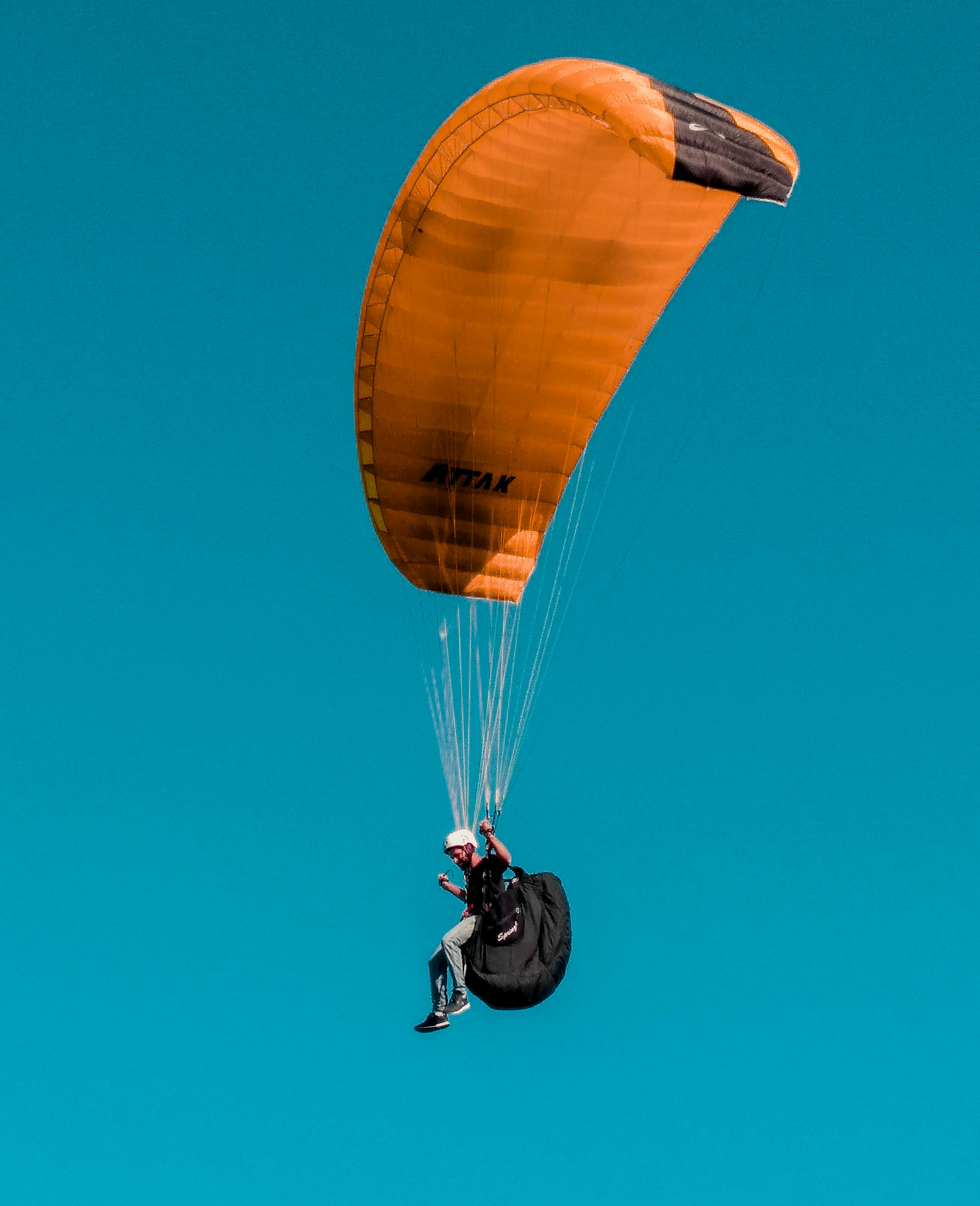 A Paraglider Above Body of Water · Free Stock Photo