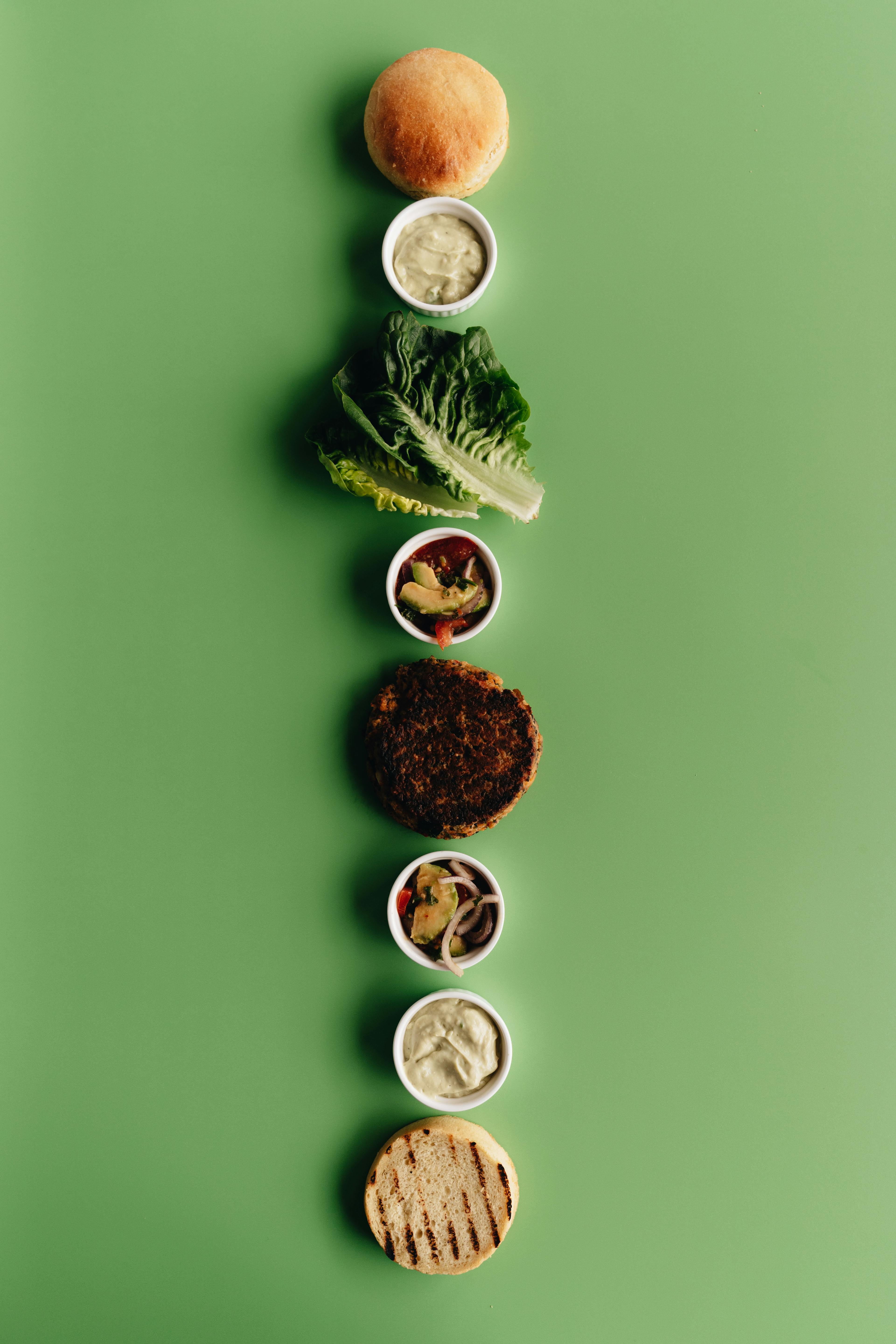 Deconstructed Burger on Green Surface · Free Stock Photo