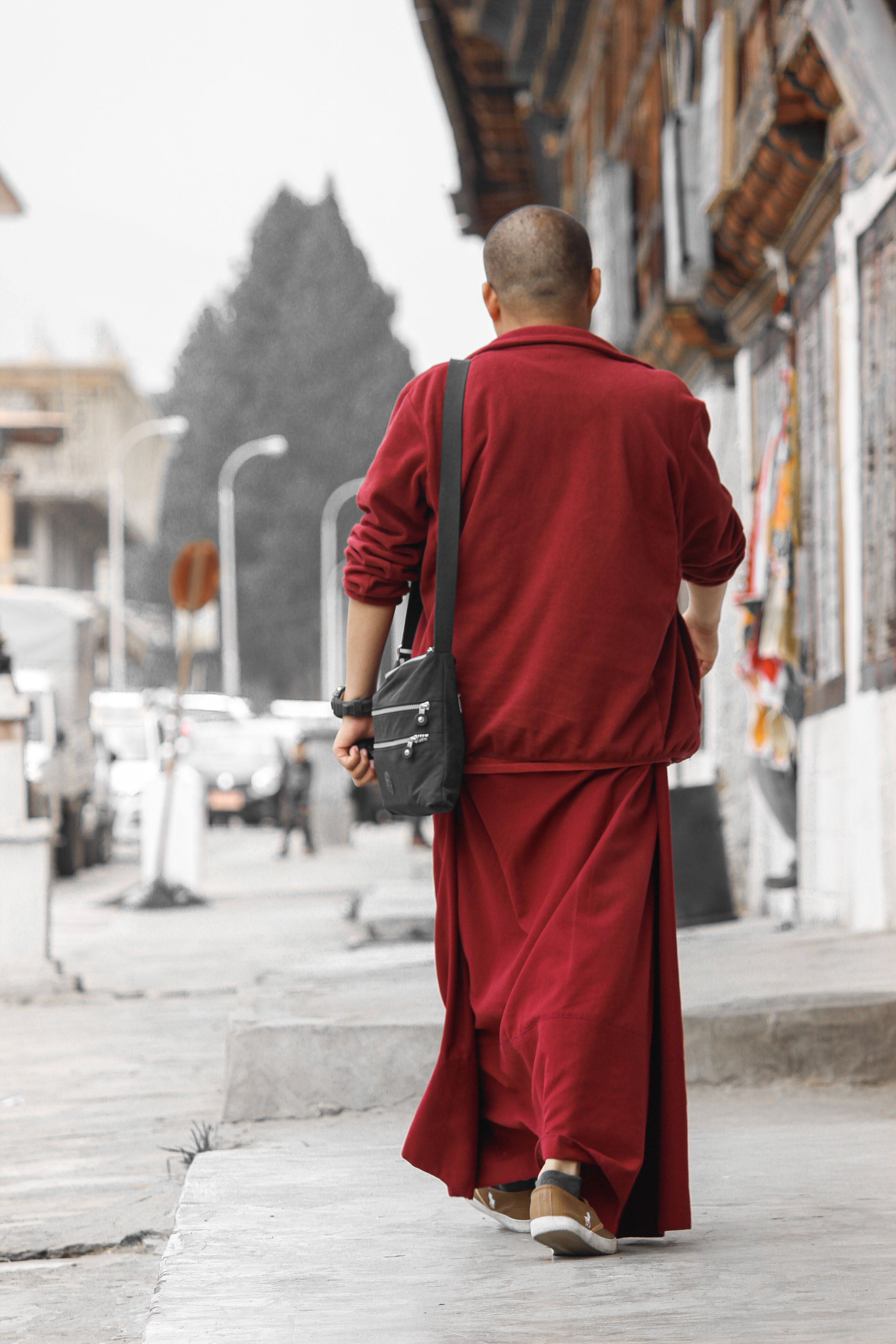 Man in Red Outfit Walking on the Street · Free Stock Photo