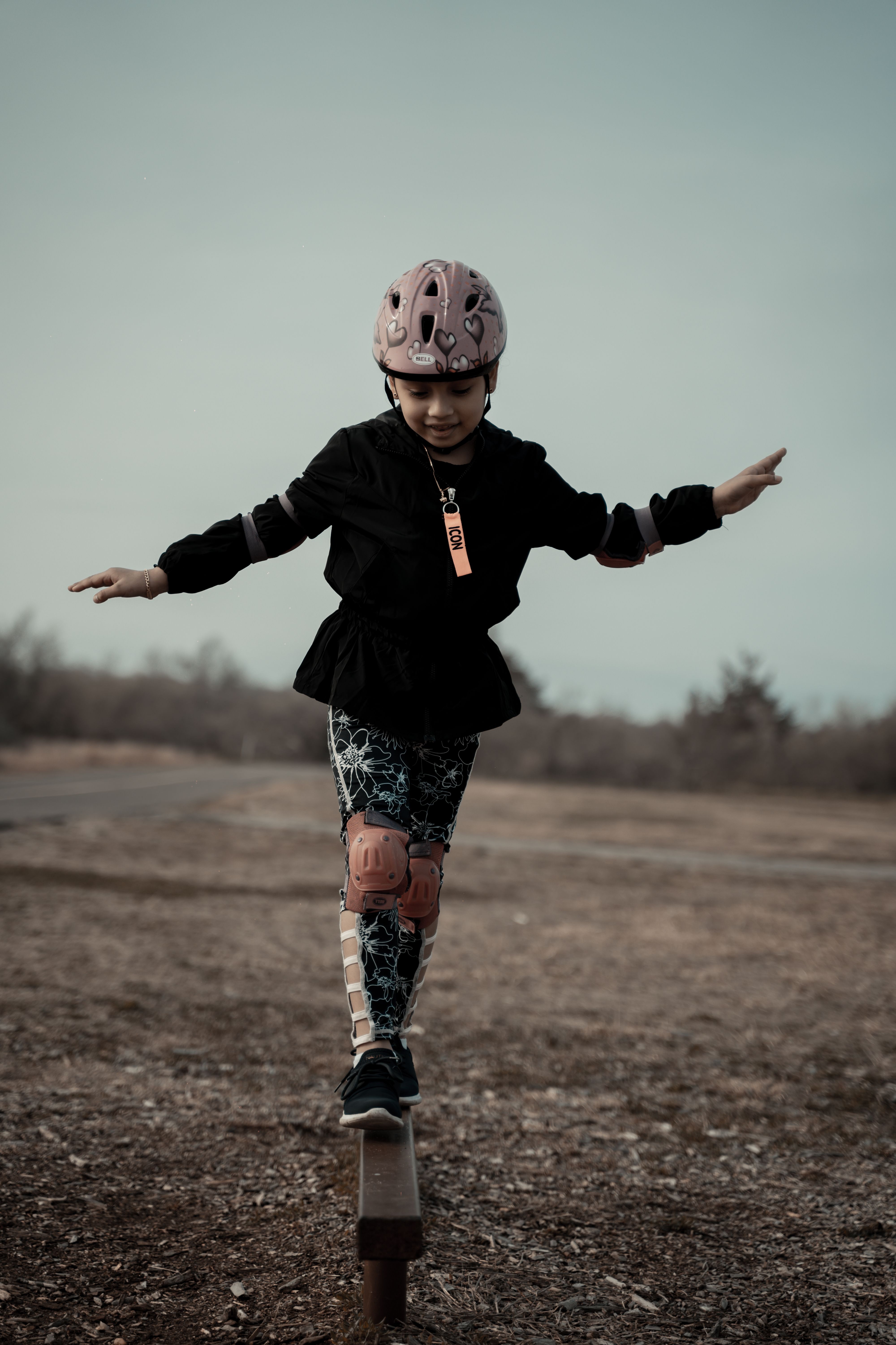 A Young Girl in a Safety Helmet Standing on a Bridge in a Rope Park ...