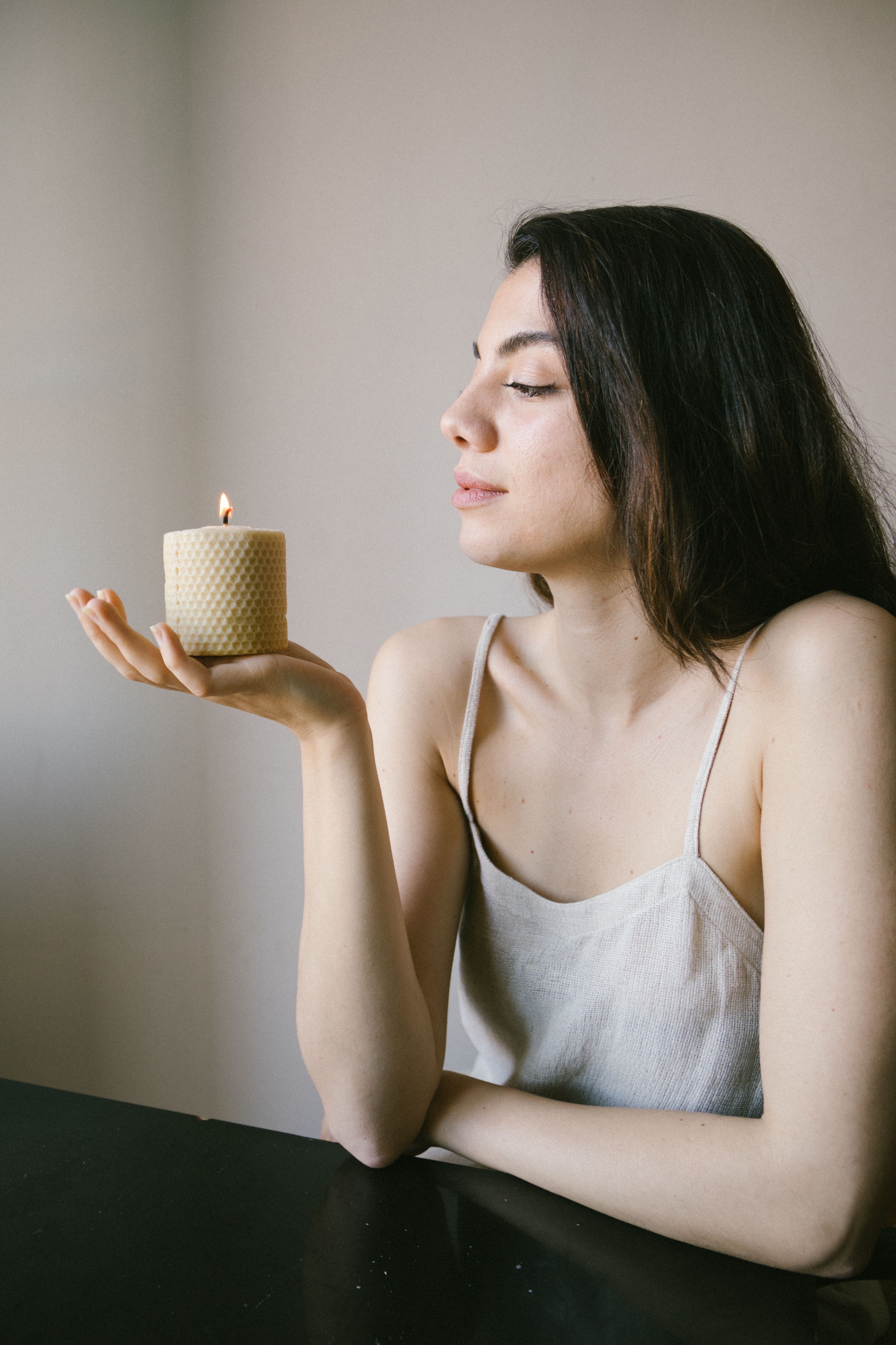 A Woman Holding Lighted Candles and a Cigarette Crying · Free Stock Photo