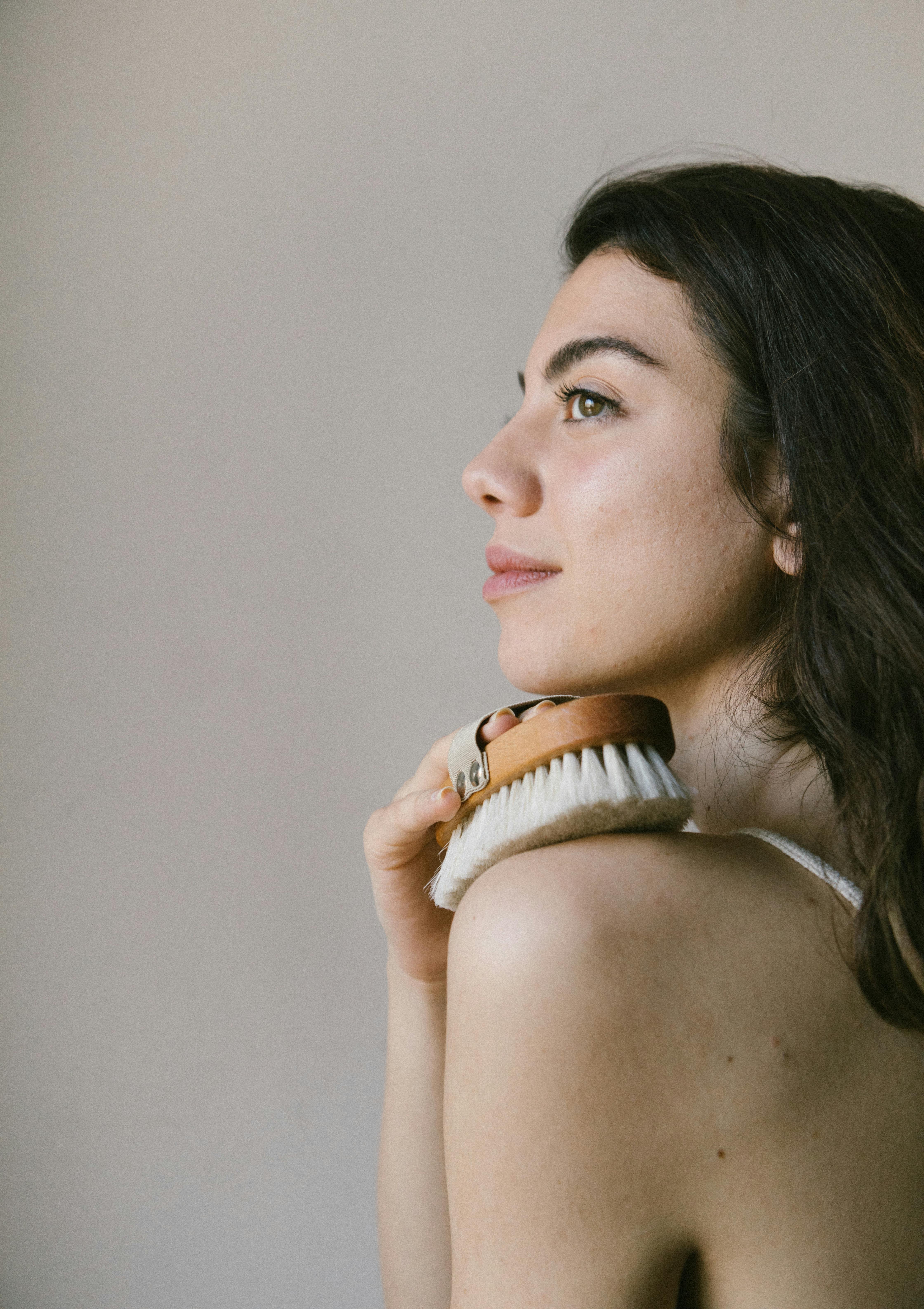 Photo of a Woman Holding a Body Brush · Free Stock Photo