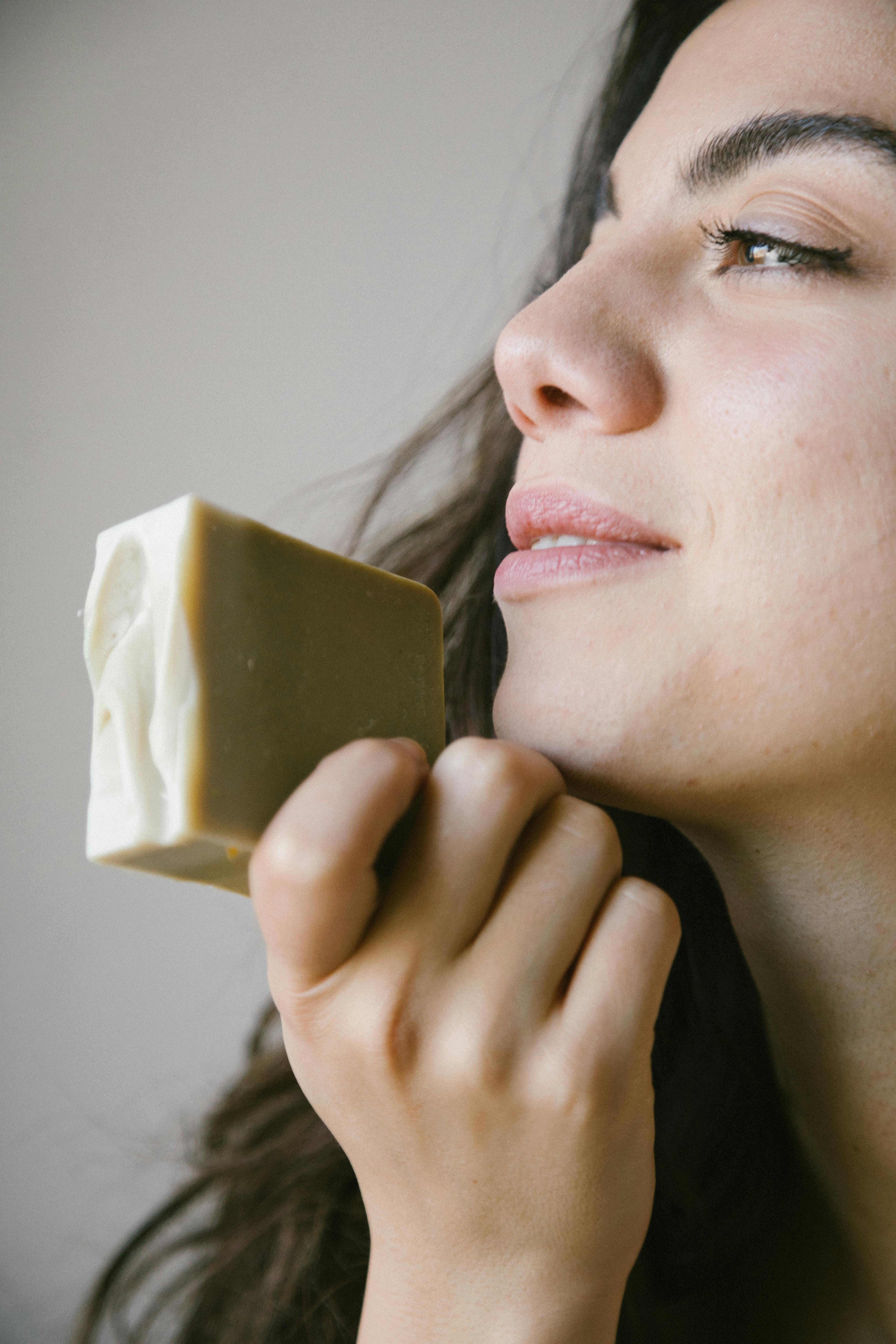 A Woman Holding a Soap Bar · Free Stock Photo