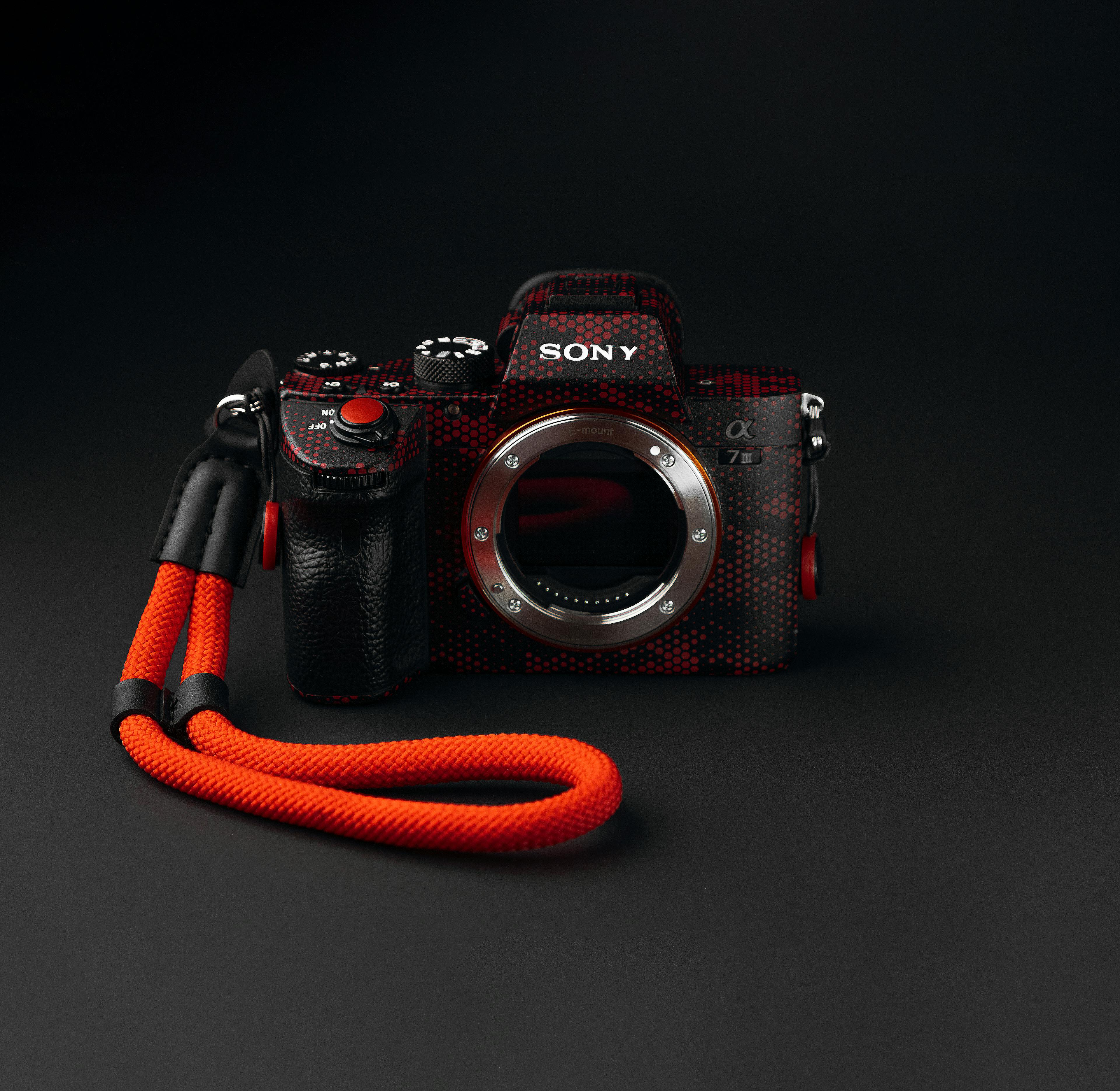 A Sony Alpha 7 III with a Red Strap · Free Stock Photo