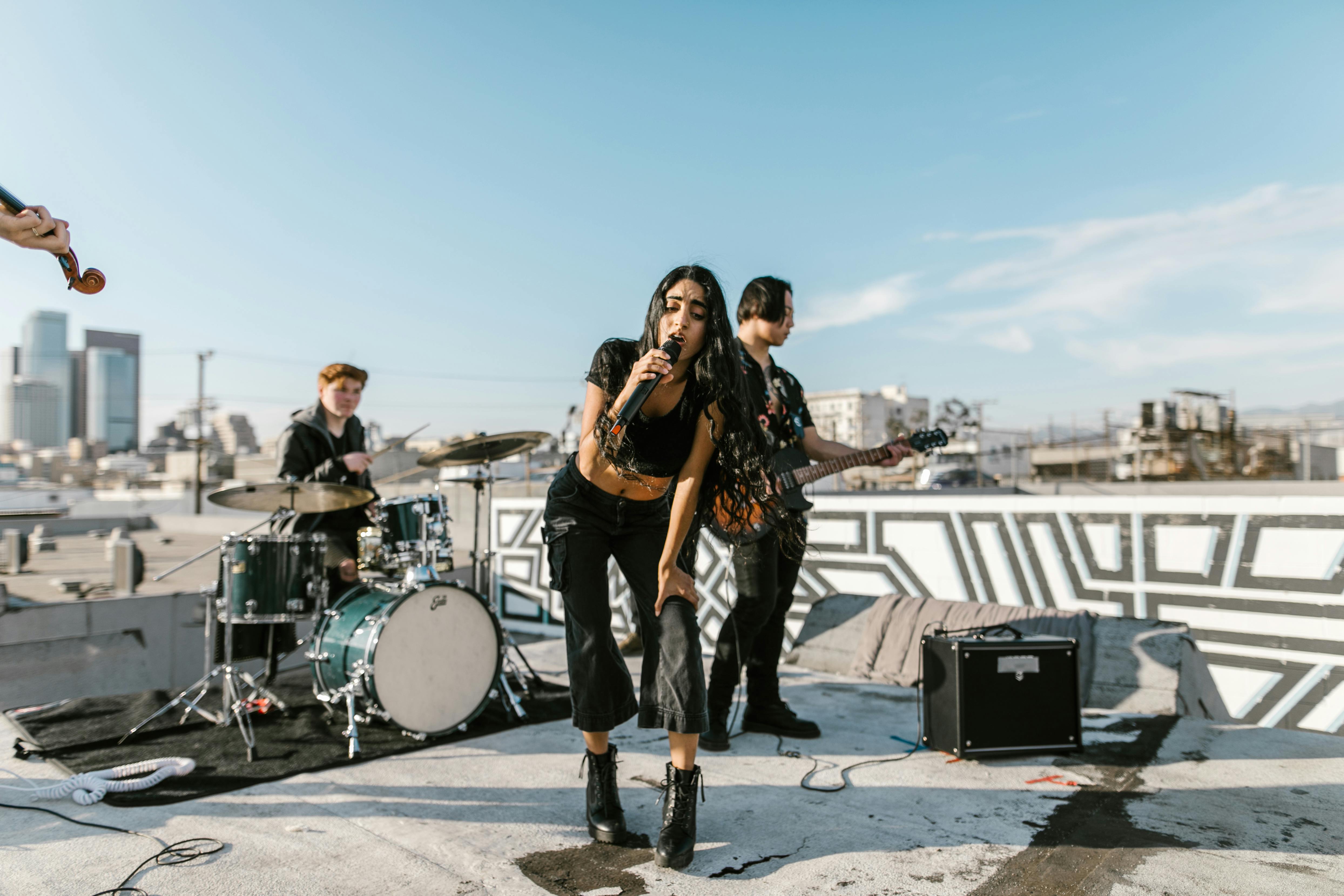 A Female Singer Standing while Recording Music · Free Stock Photo