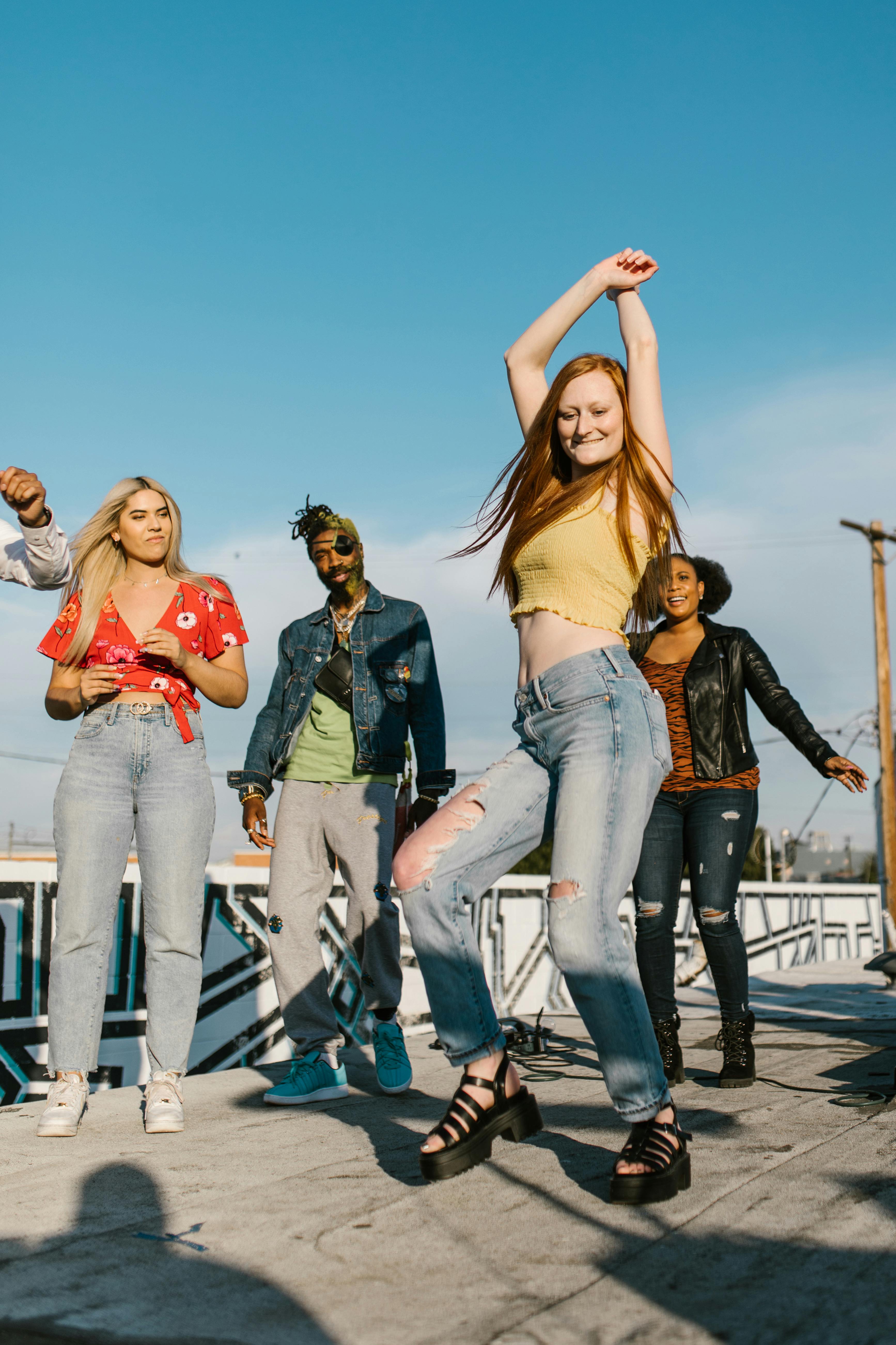 A Woman in Ripped Jeans and Yellow Crop Top Dancing · Free Stock Photo