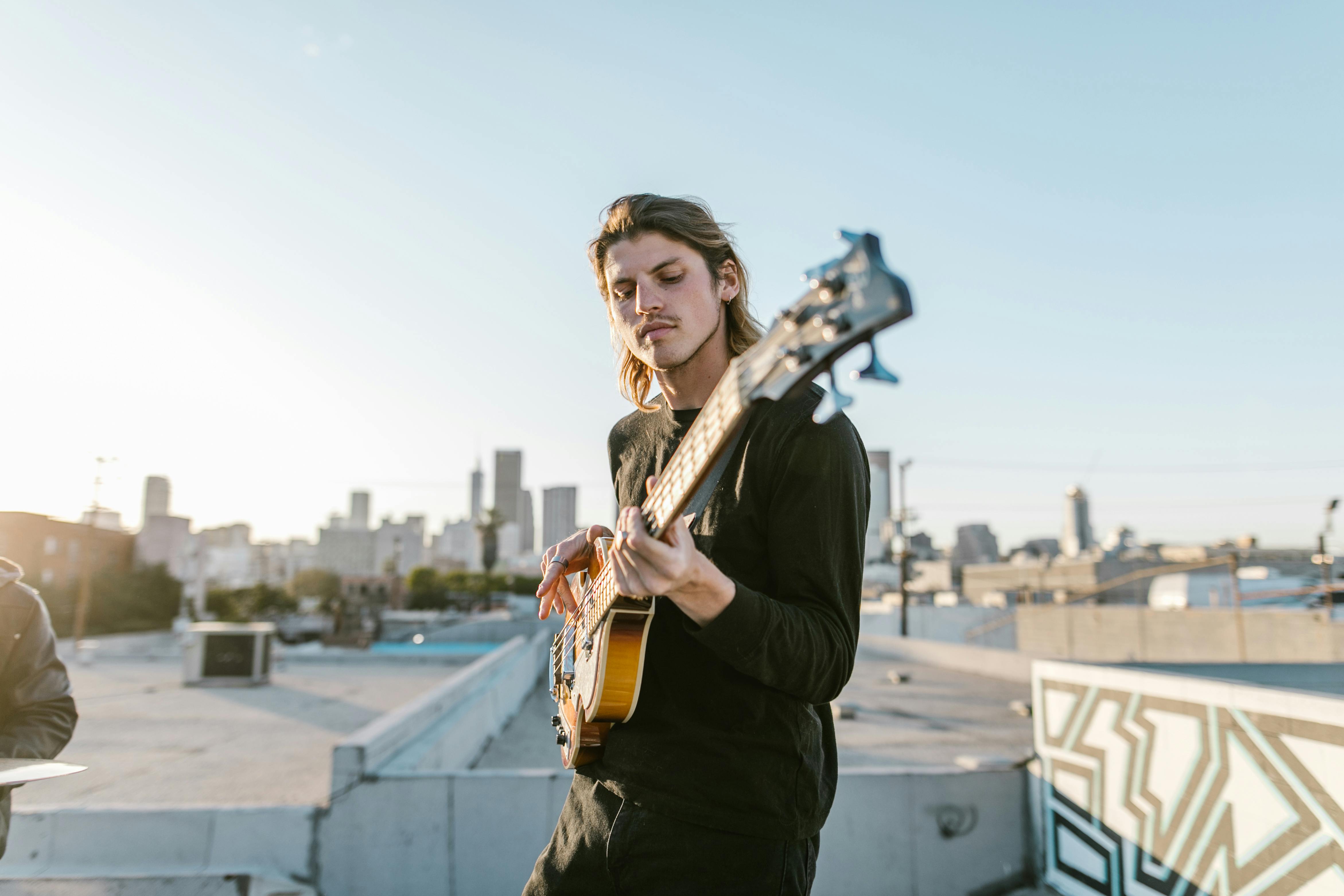 A Man Playing the Bass Guitar · Free Stock Photo