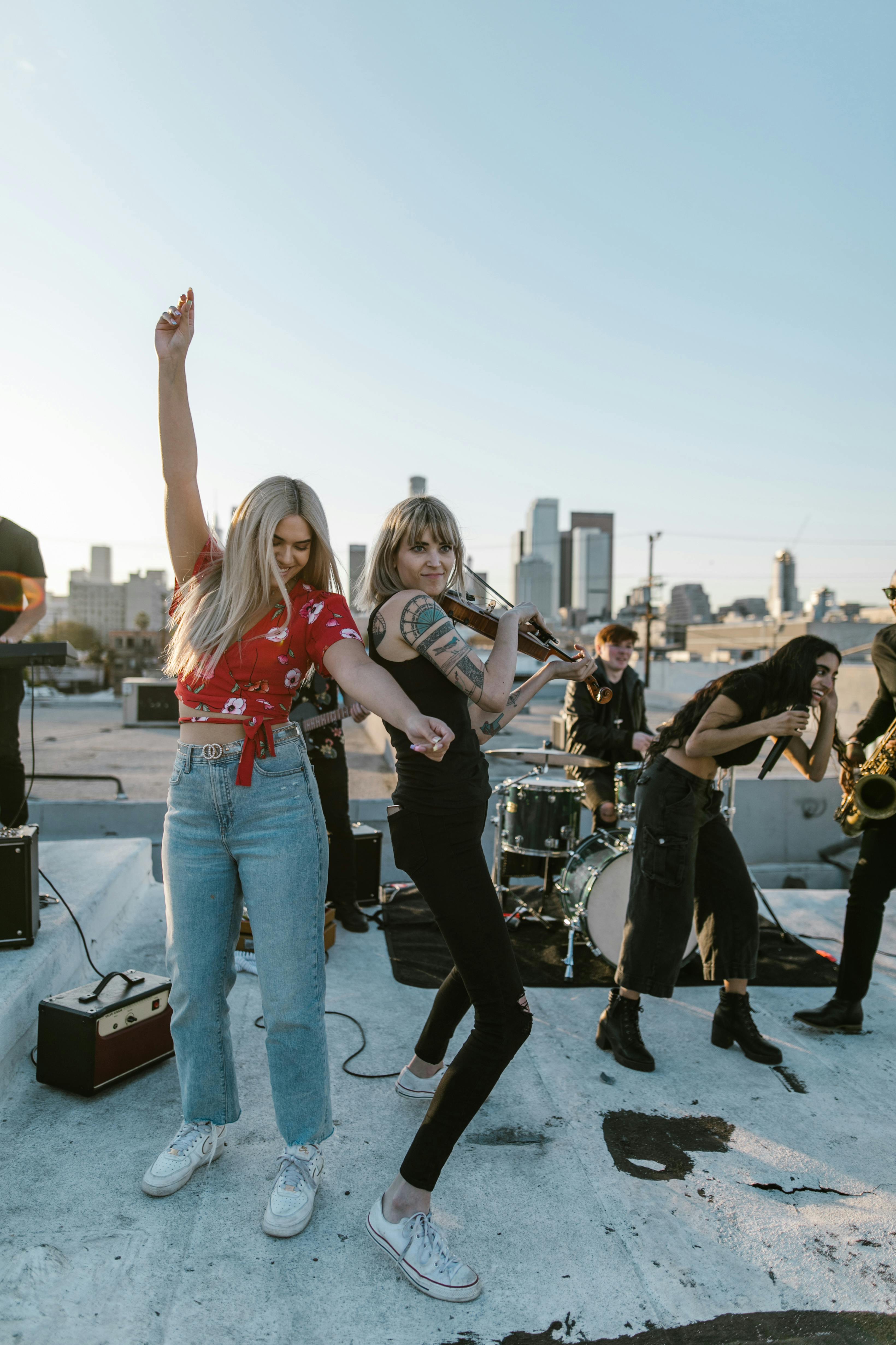 Two Women Dancing and Playing Violin · Free Stock Photo