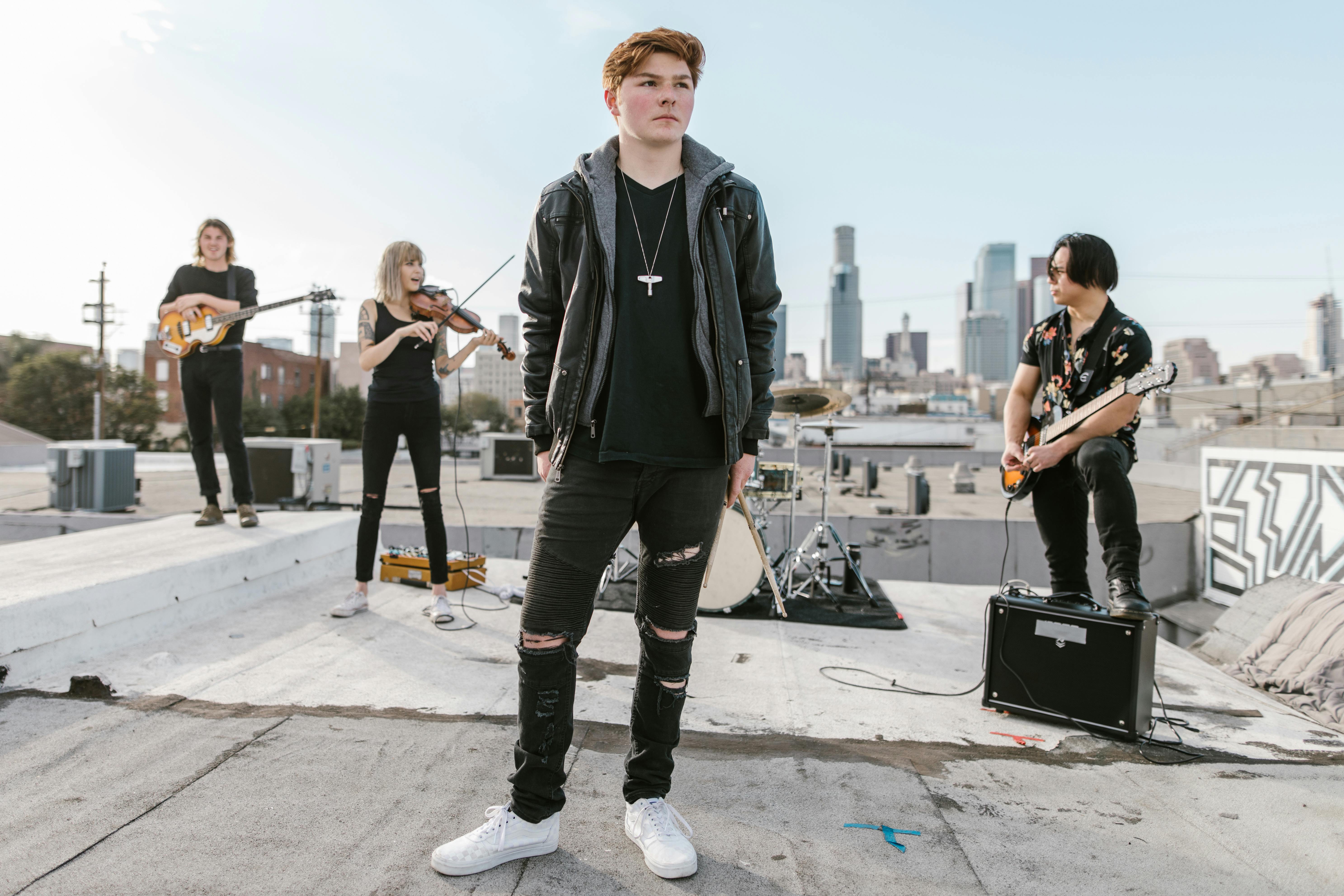 A Band Playing Musical Instruments on the Rooftop · Free Stock Photo